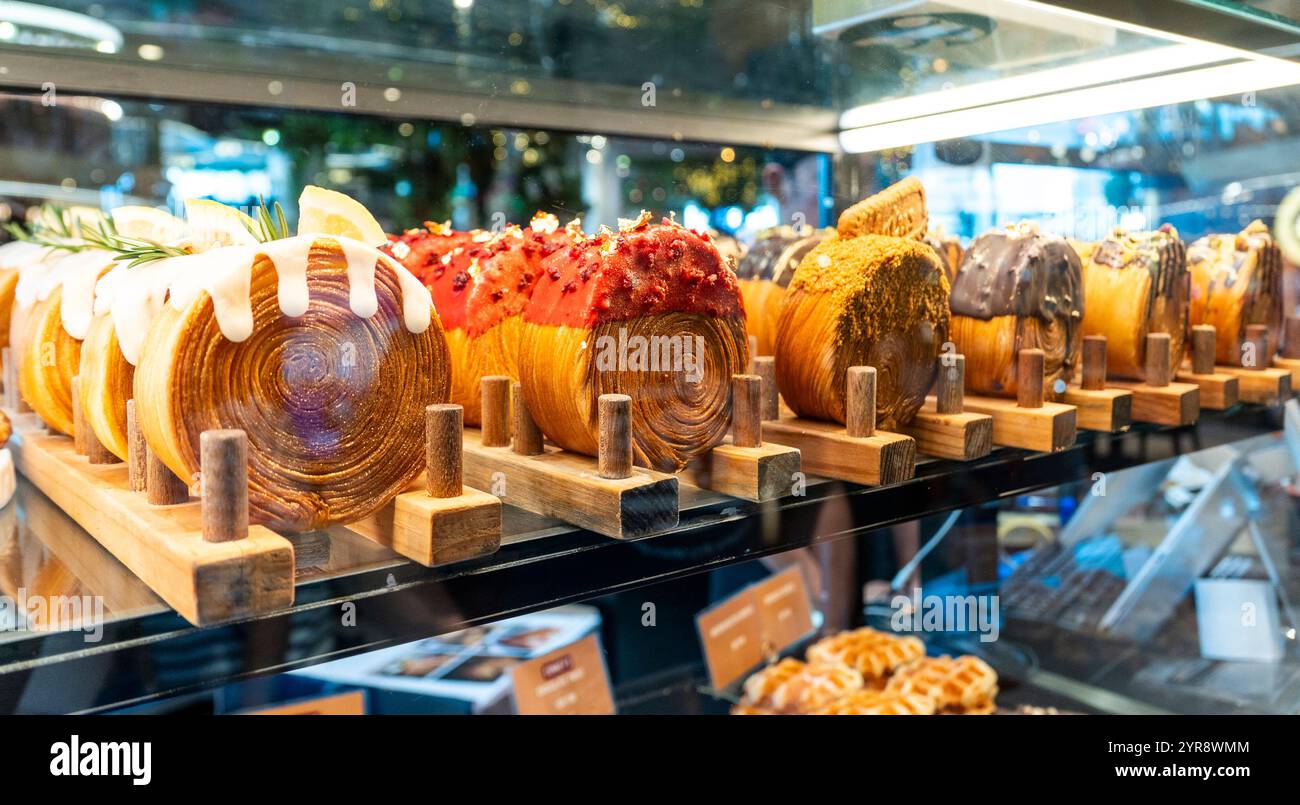 Tempting selection of gourmet pastries displayed in a bakery at night ...