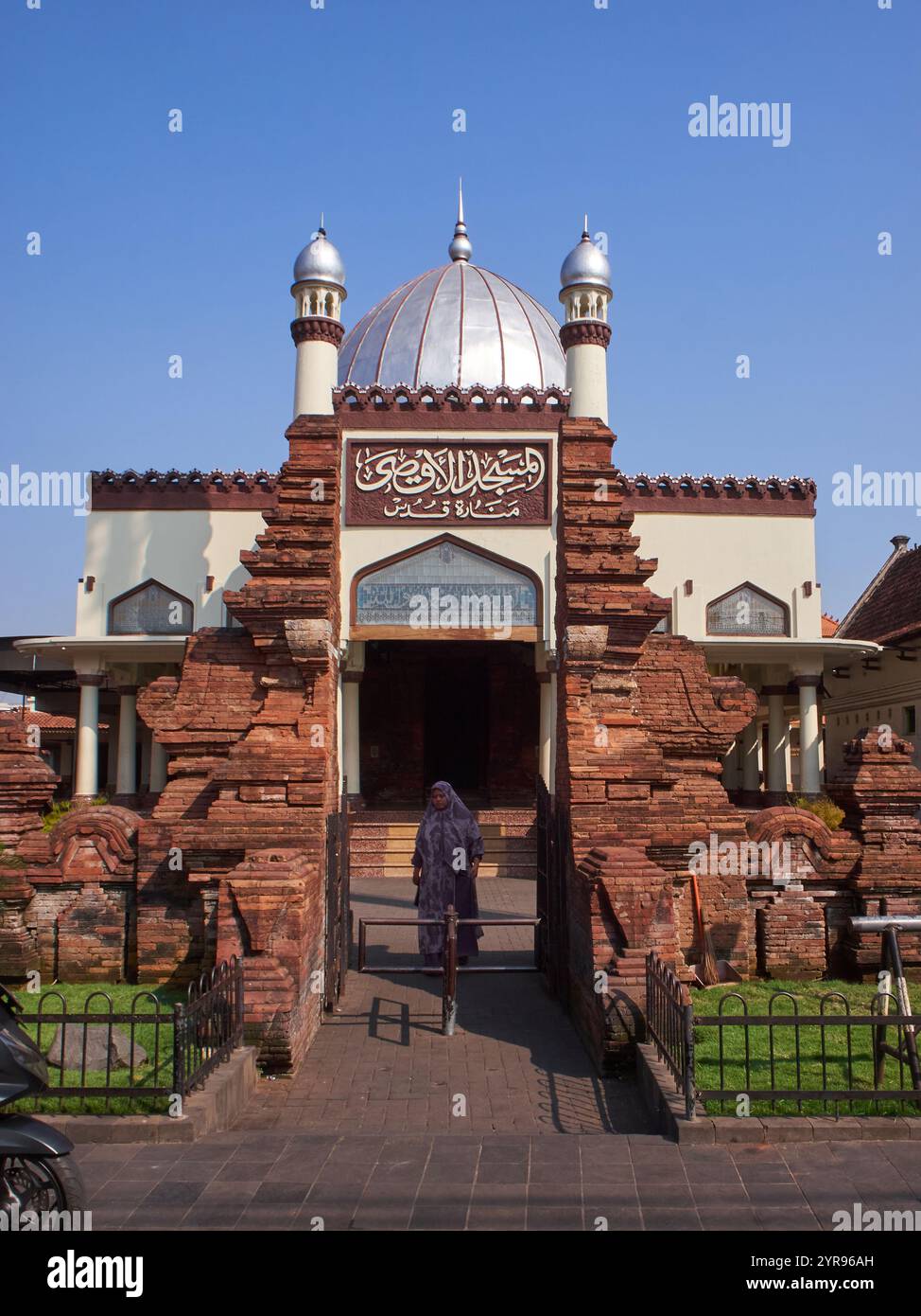 Front view of mosque which has Arabic calligraphy that informs its name ...