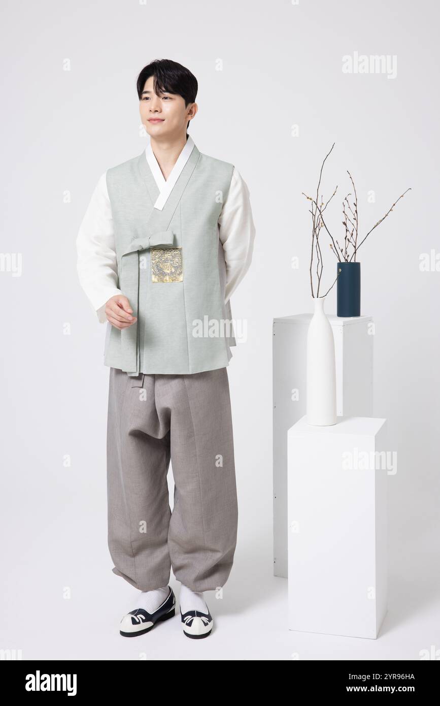 A young man standing wearing a hanbok Stock Photo - Alamy