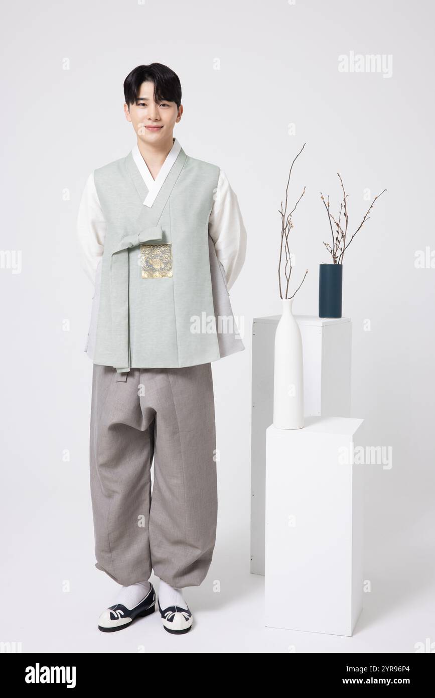 A young man standing wearing a hanbok Stock Photo - Alamy