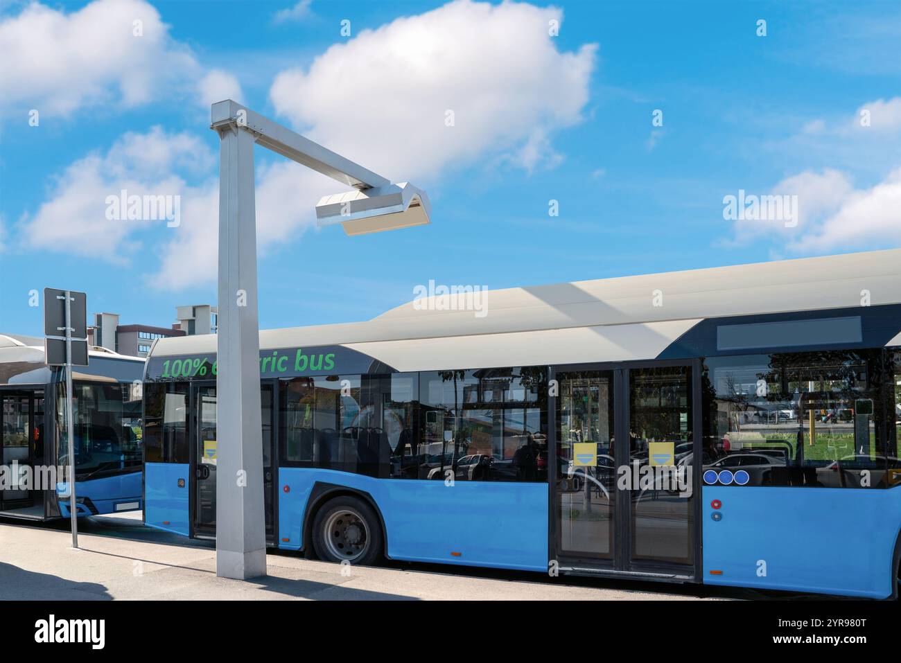 Pantograph charging electric buses station in city in front of summer ...