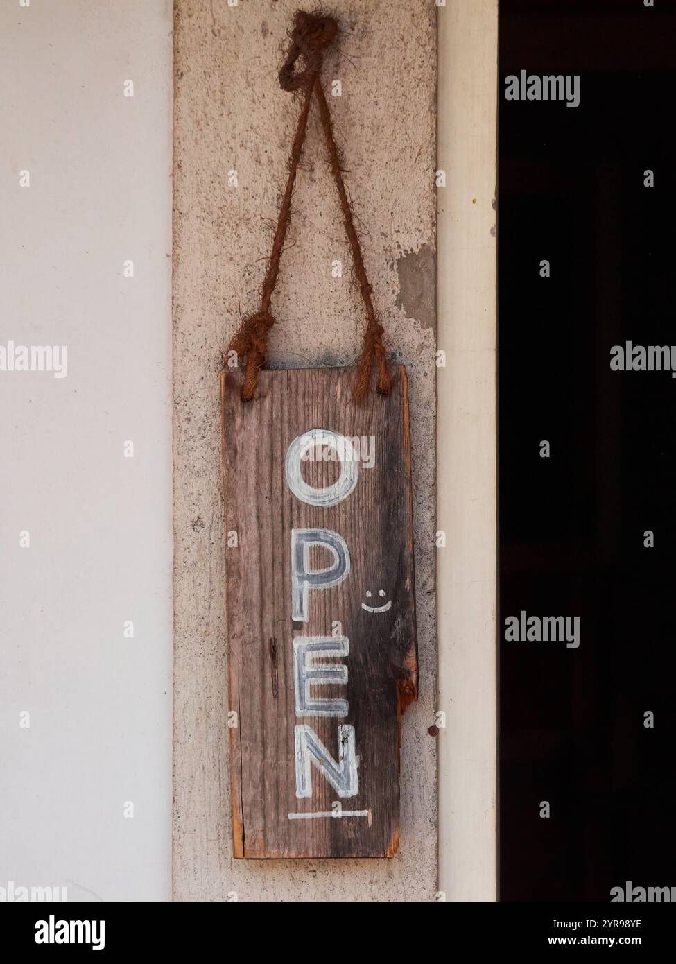 An open sign hanging on wall looks worn and old fashioned Stock Photo ...