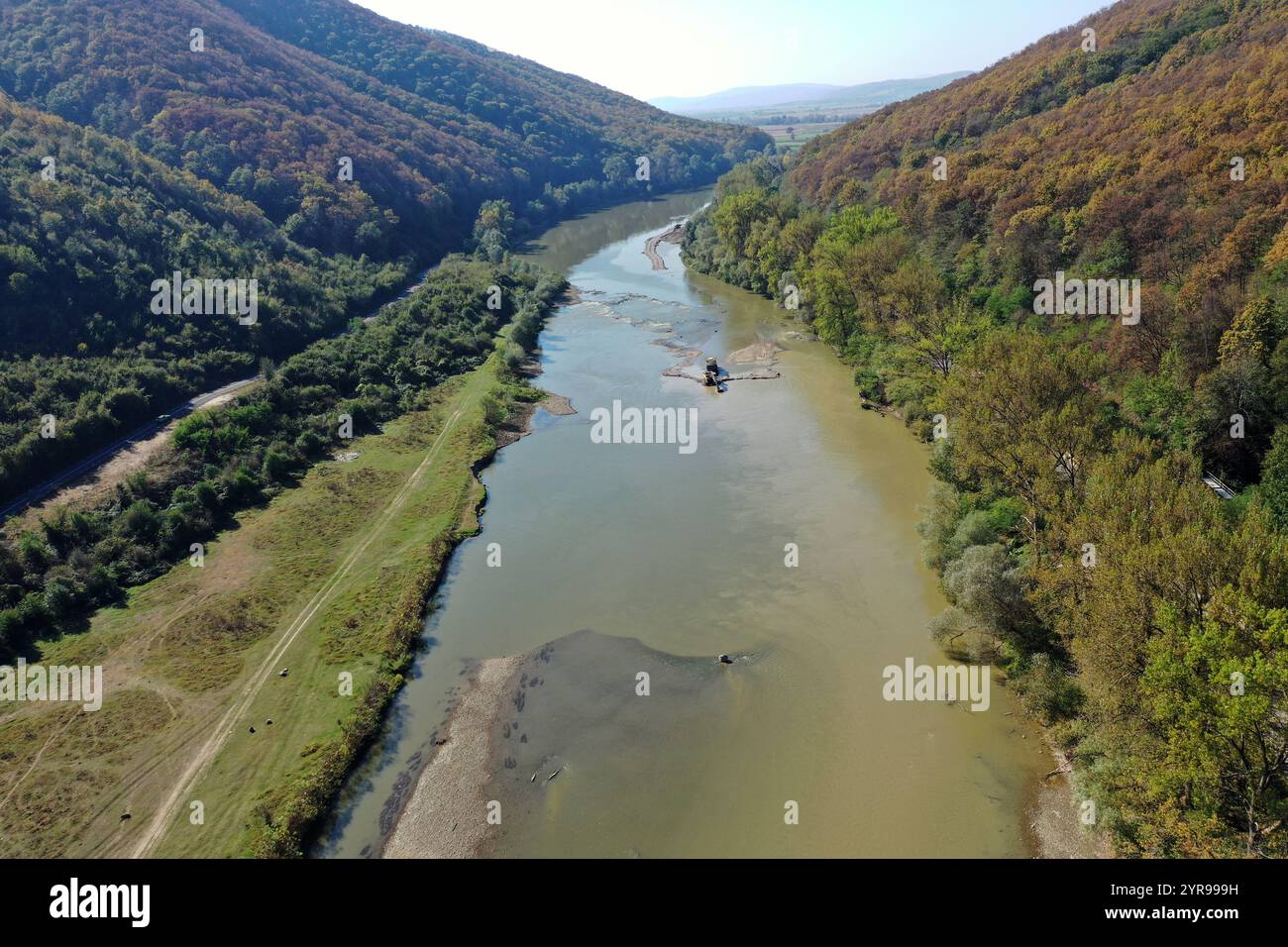 Aerial view of backhoes digging sand and gravel with shovels from the ...