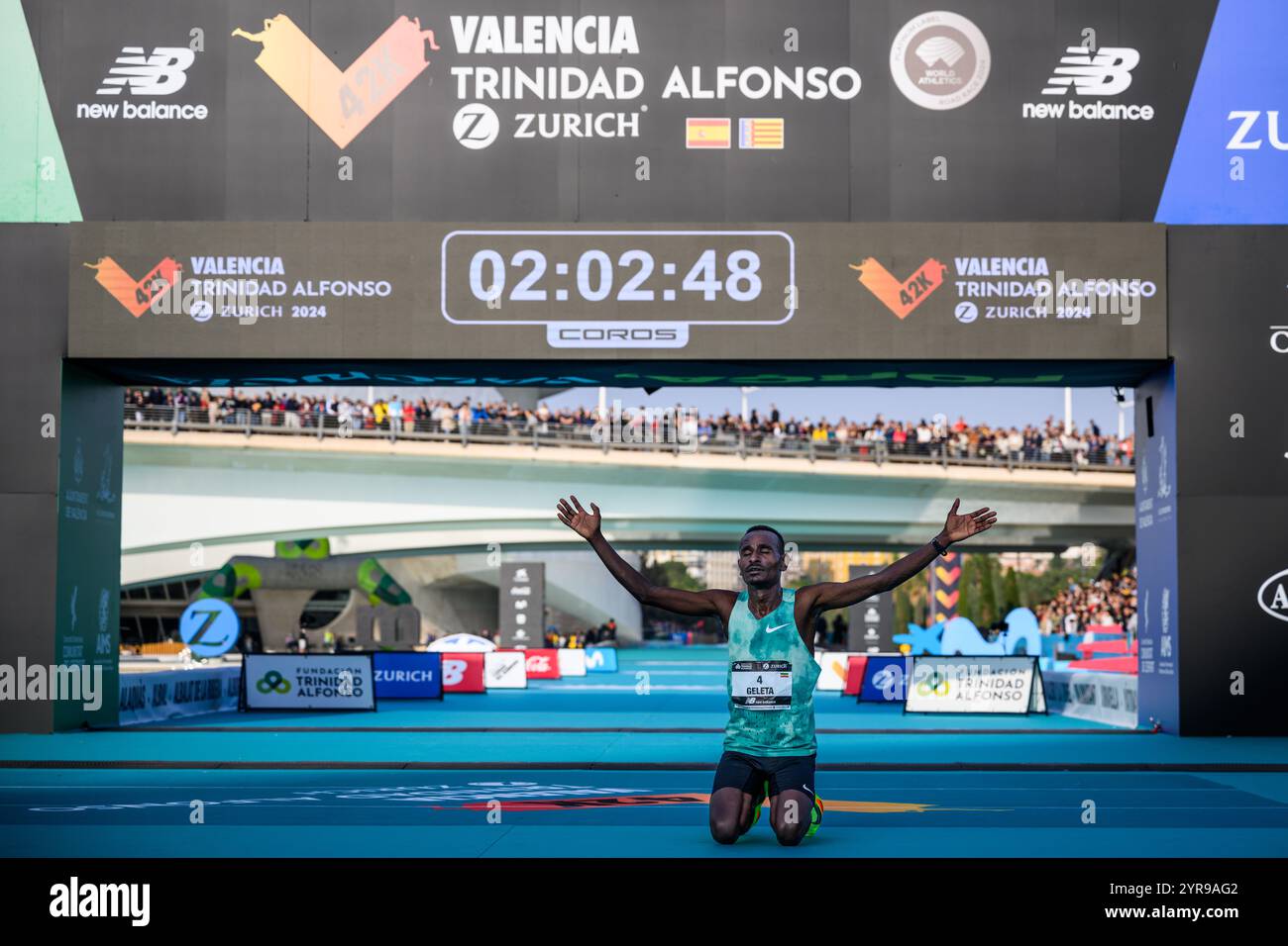 Ethiopian runner, Deresa Geleta, praying on his knees in front of the ...