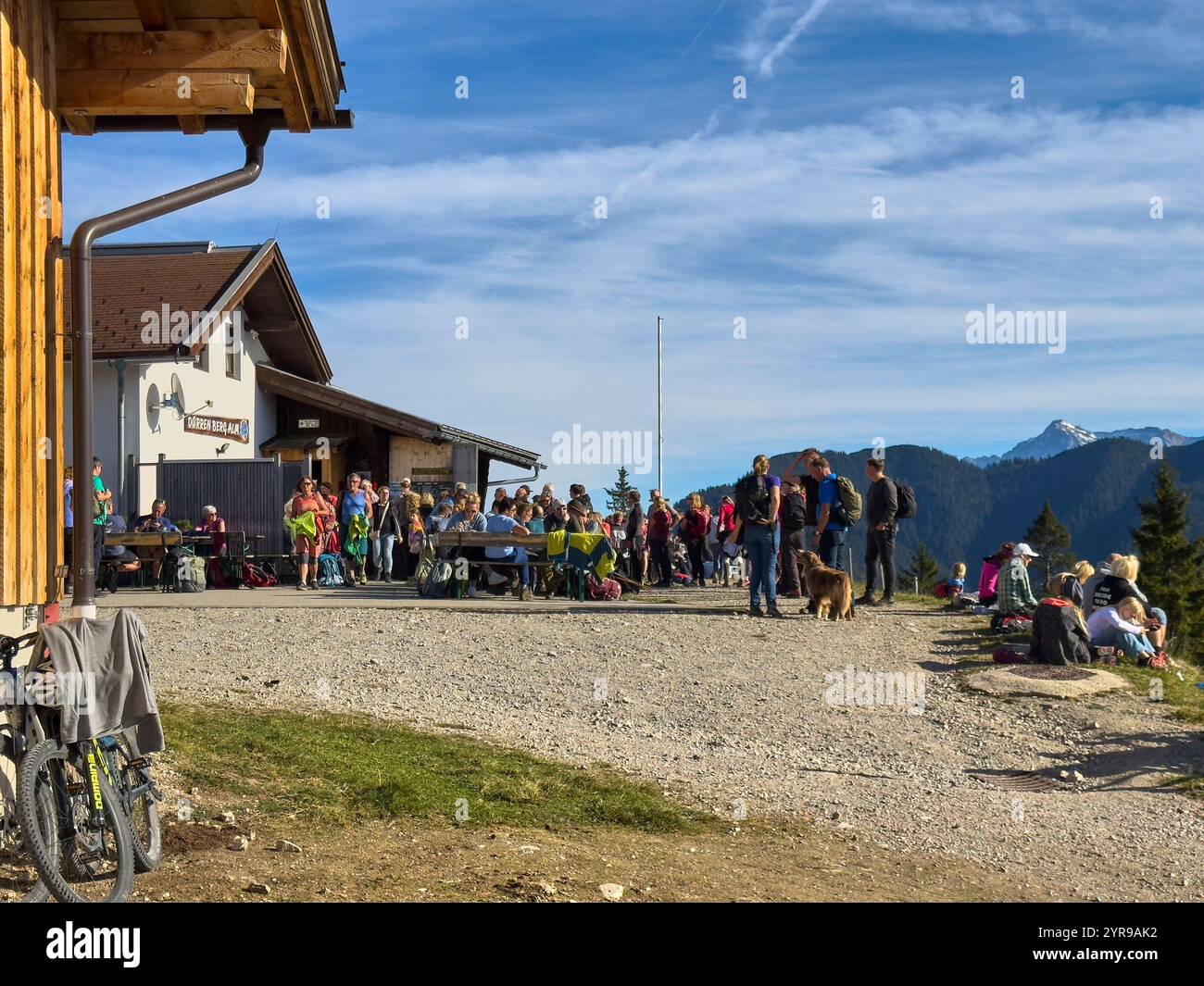 Hikers, tourists and hikers with dogs on the Duerrenberg Alm with a ...