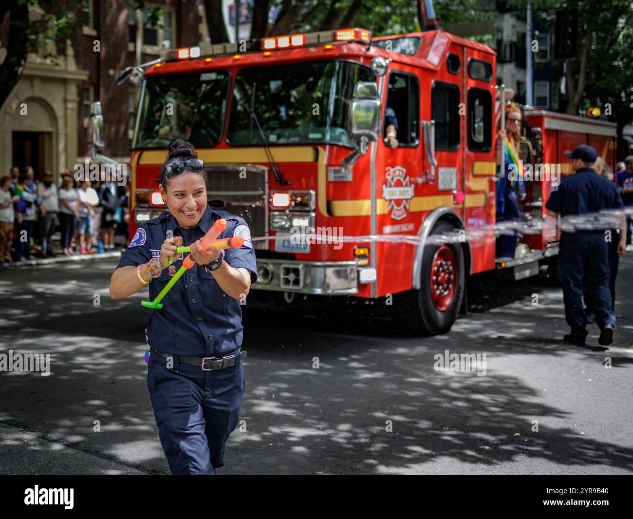 Firefighter from Seattle Fire Department cooling off the crowd during ...