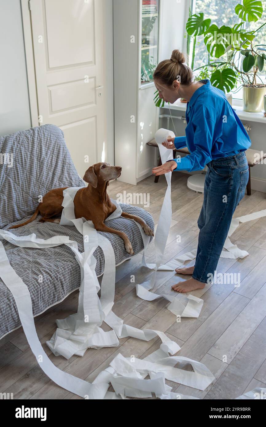 Dog causes humorous chaos, unraveled toilet paper around room, while ...