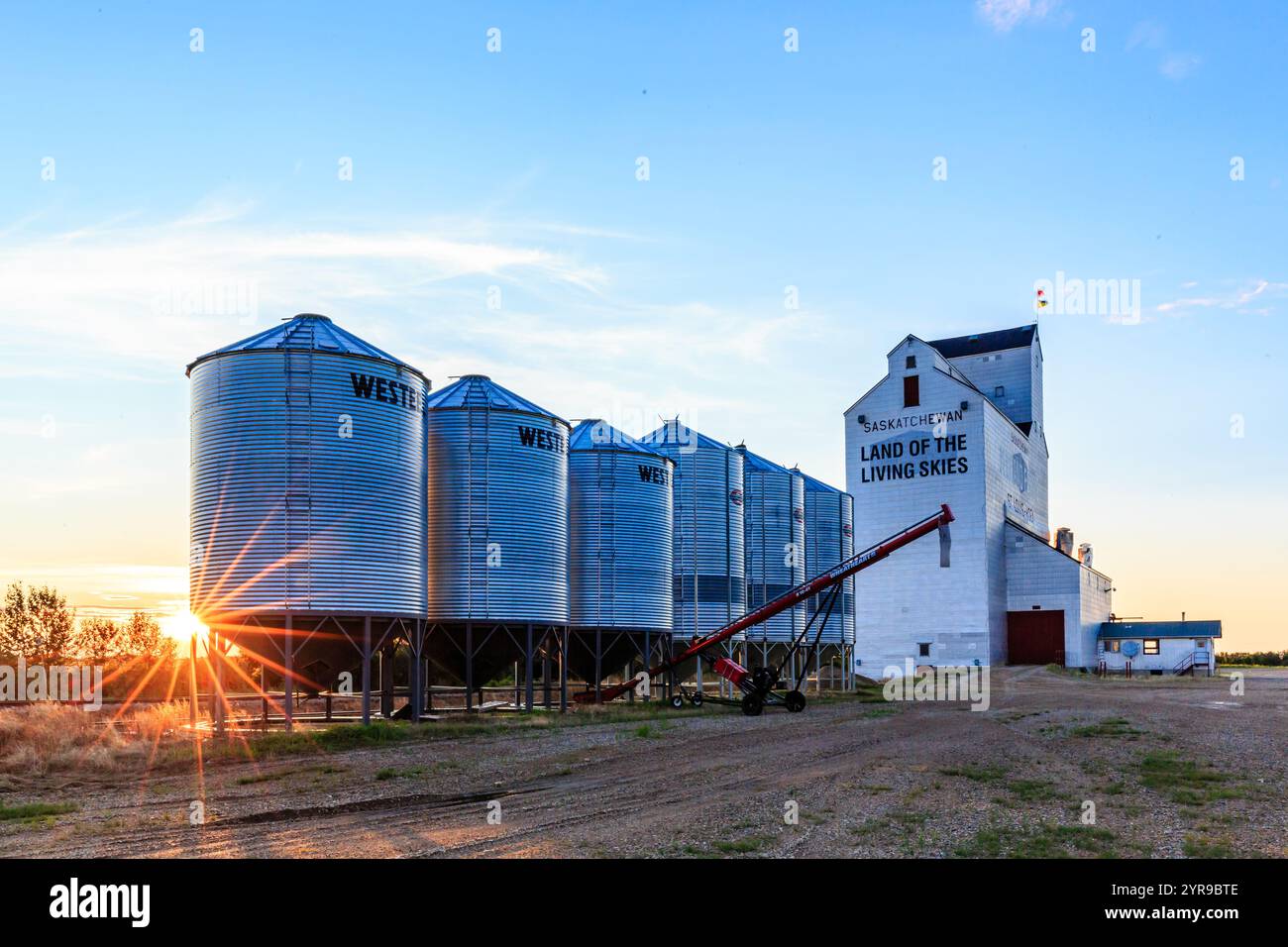 A large grain silo with the words "Land of the Lamb" on it. The silo is ...
