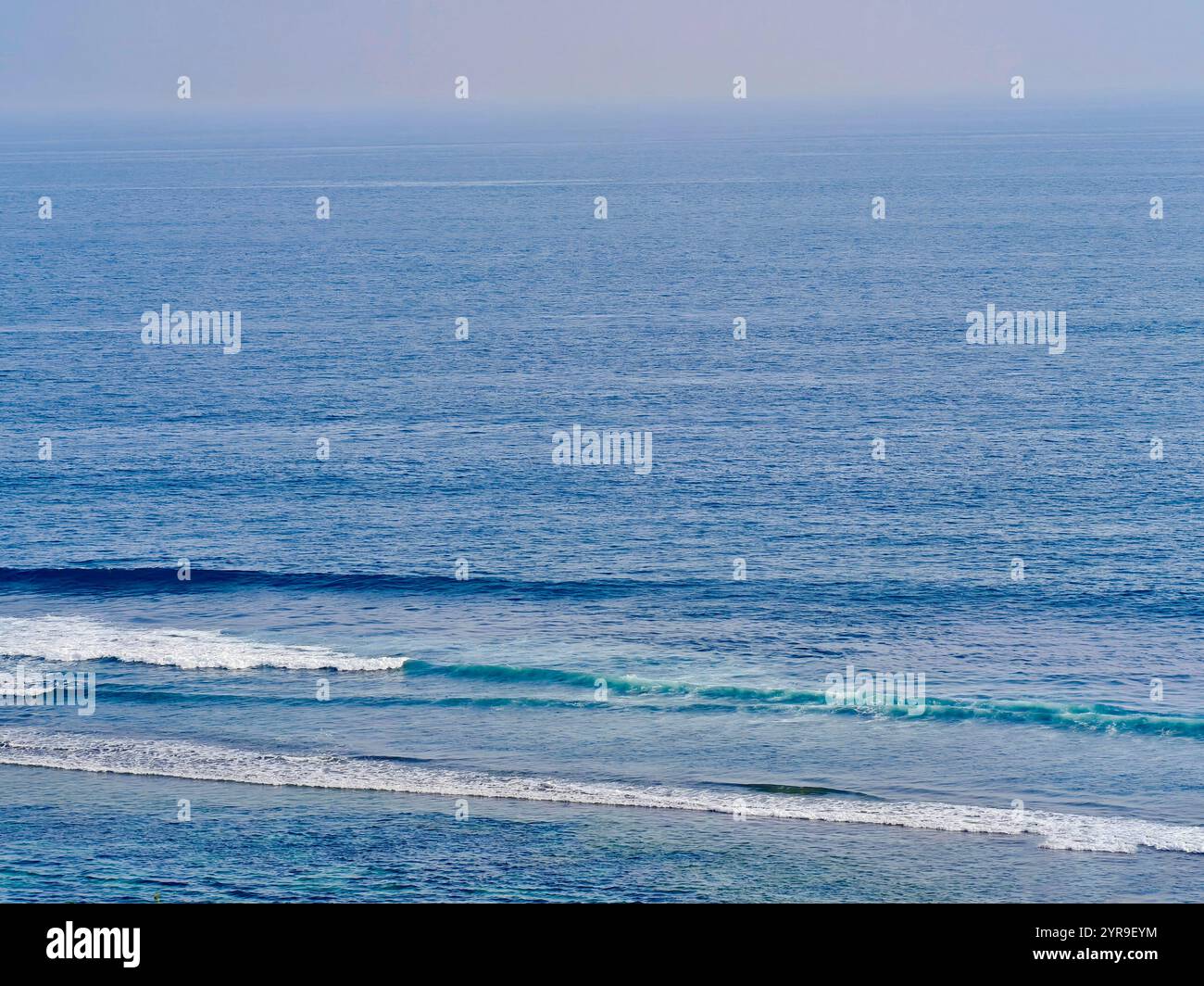 The calm ocean horizon stretches endlessly, where the tranquil blue of ...