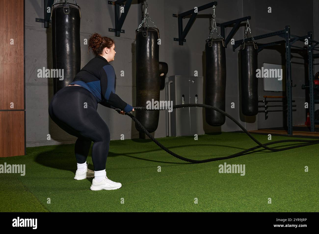 Engaging in intense battle rope drills aimed at building strength and ...