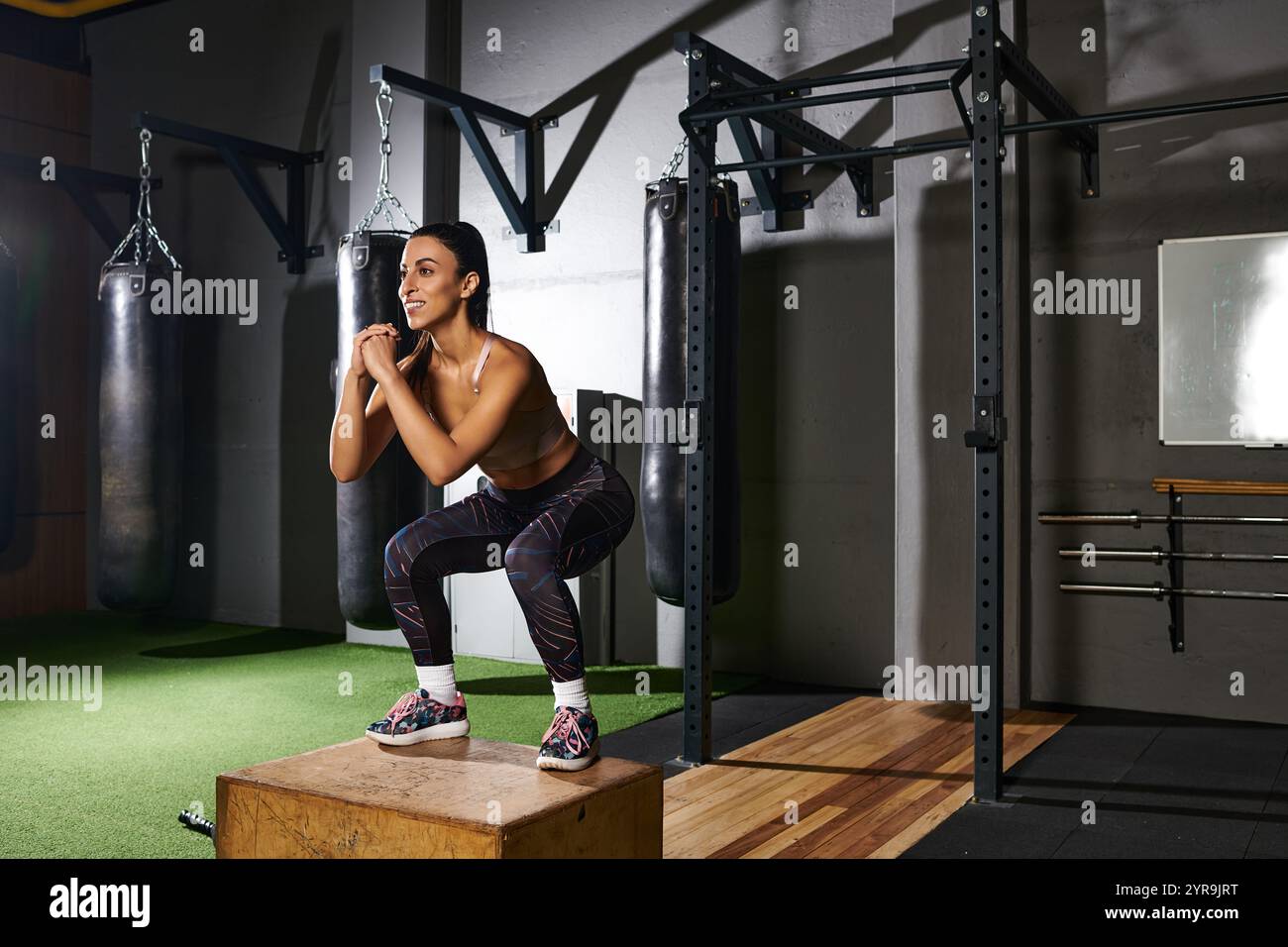 Dedicated woman performs box squats, displaying strength and ...