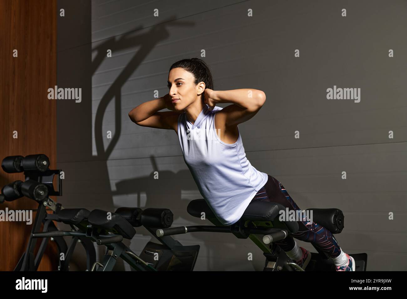 Female woman engages in a challenging workout targeting core muscles in ...