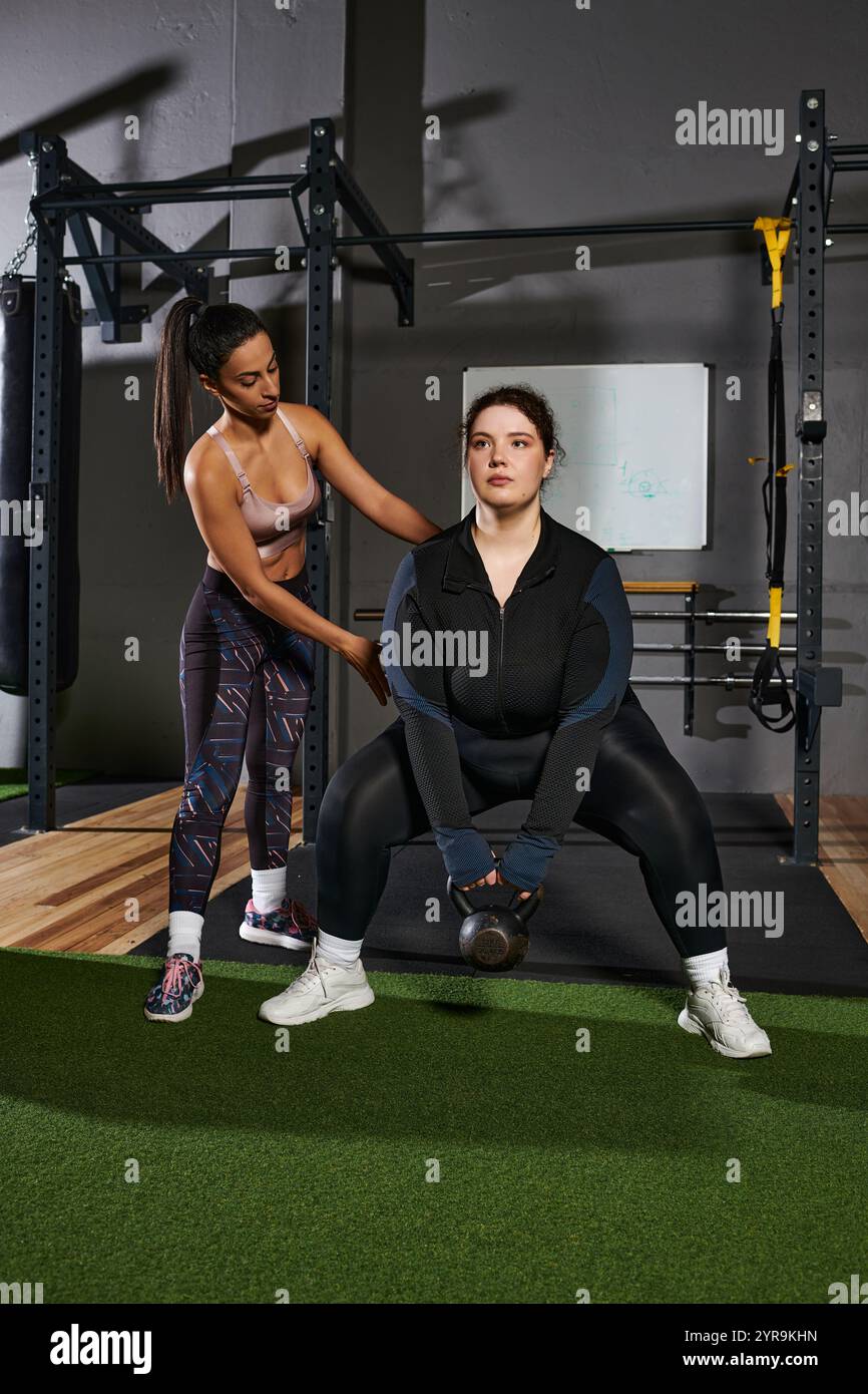 Trainer provides support to beginner as she lifts weights in a well ...