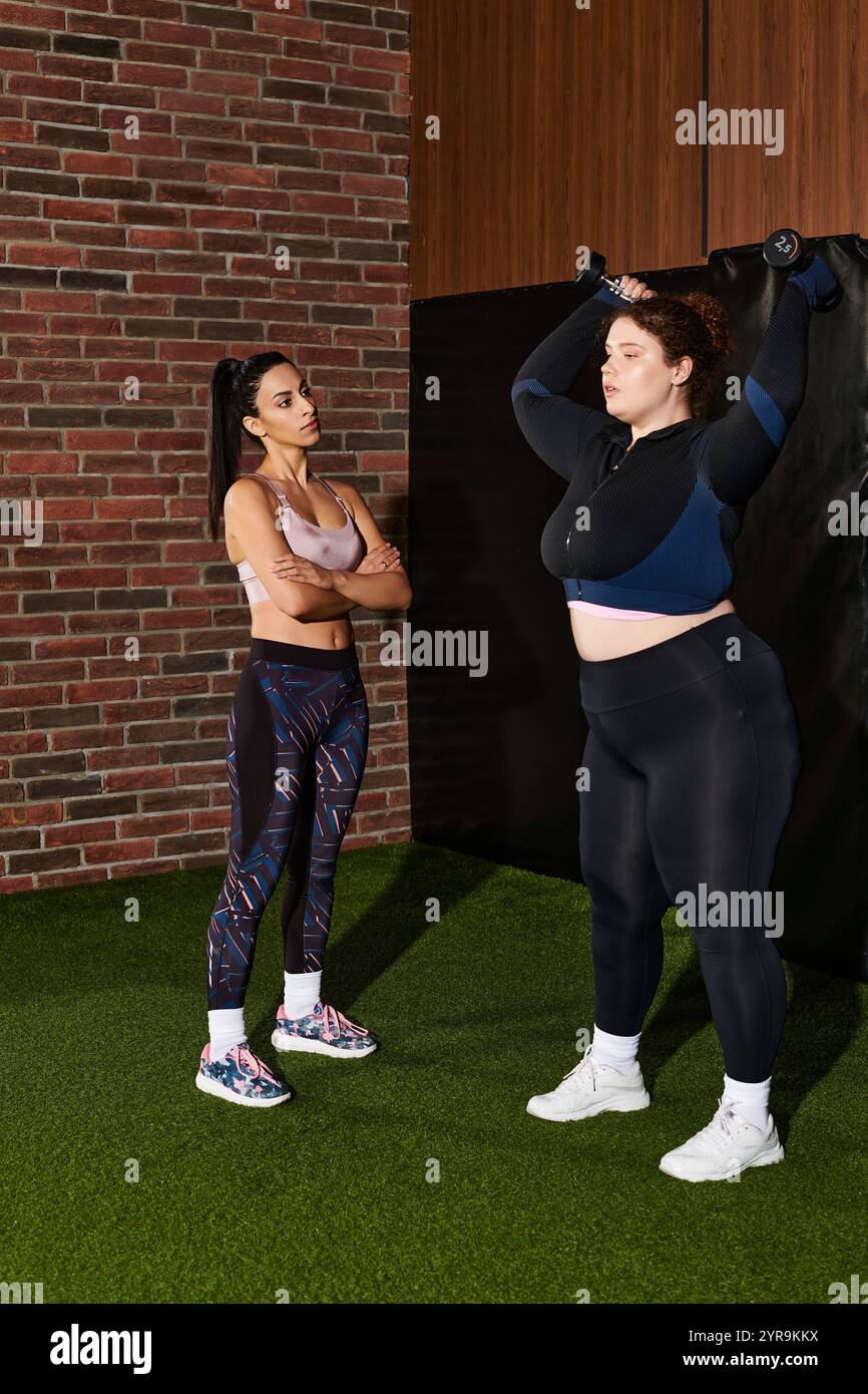 Two women engaged in a focused workout, showcasing strength and ...