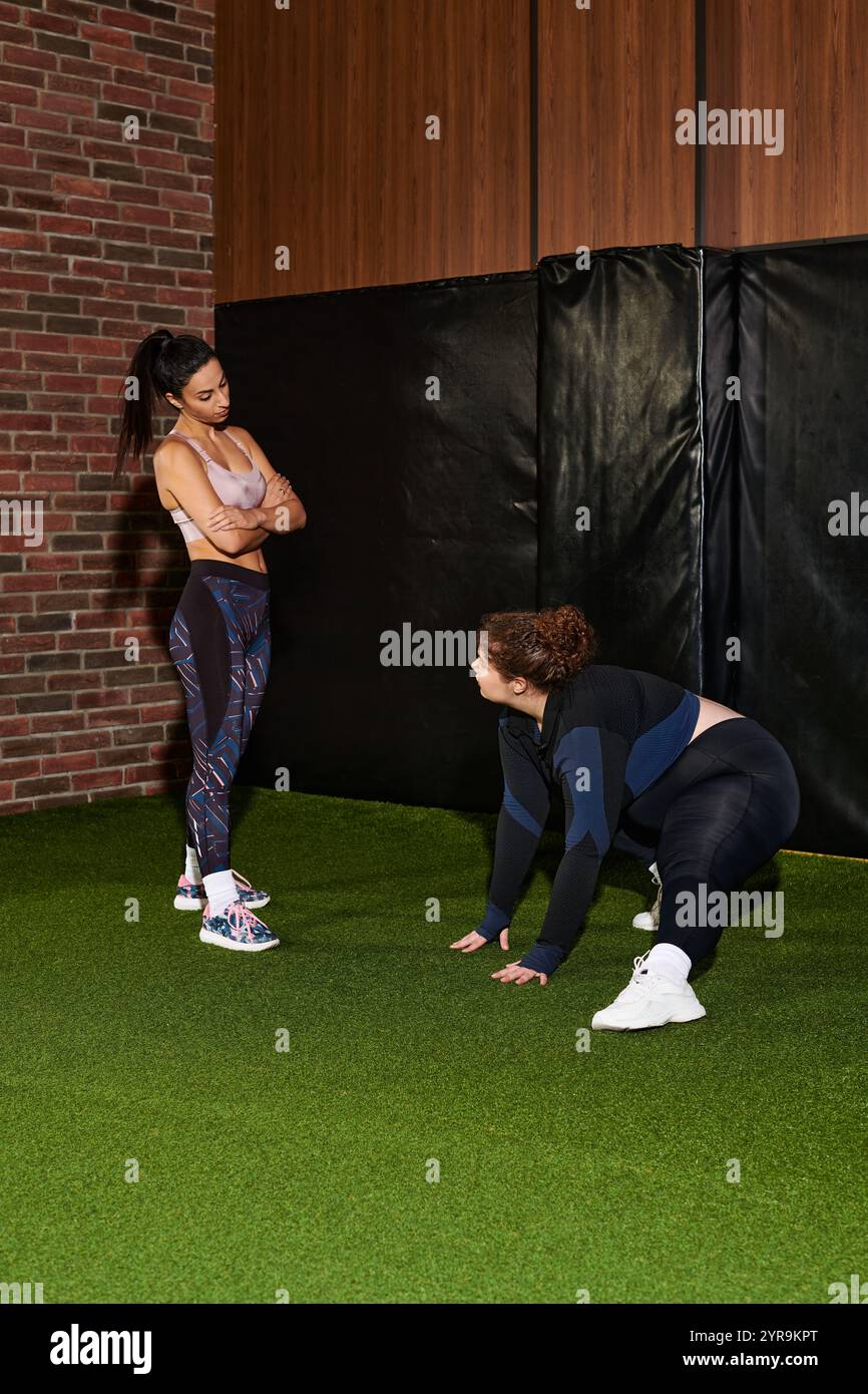 Two women push each other to excel while working out in a modern gym ...