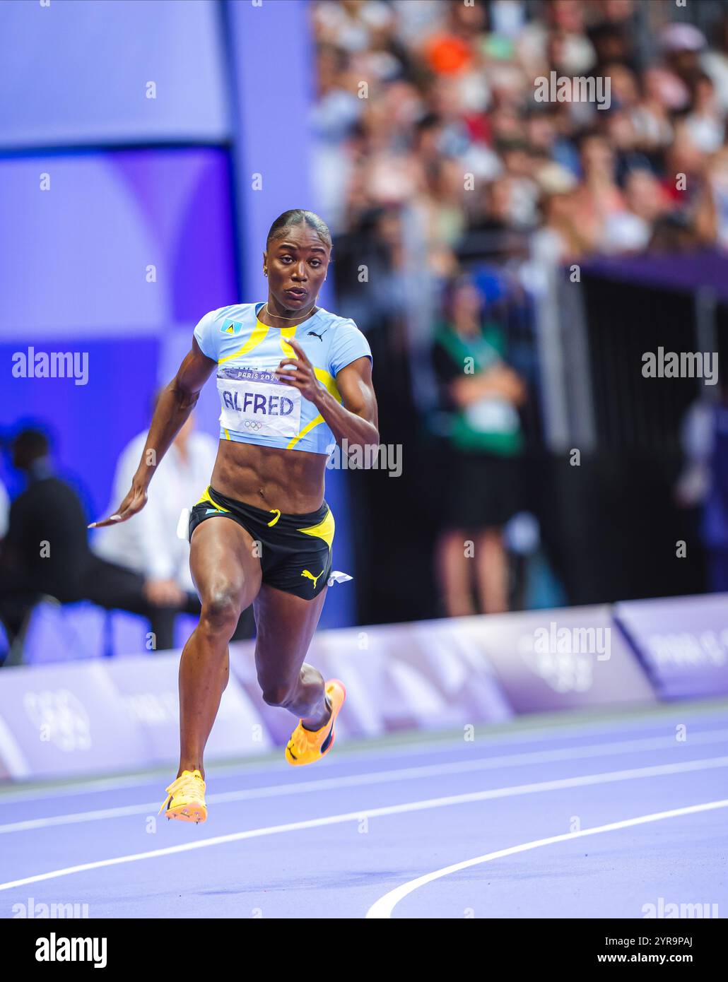 Julien Alfred participating in the 200 meters relay at the Paris 2024 ...