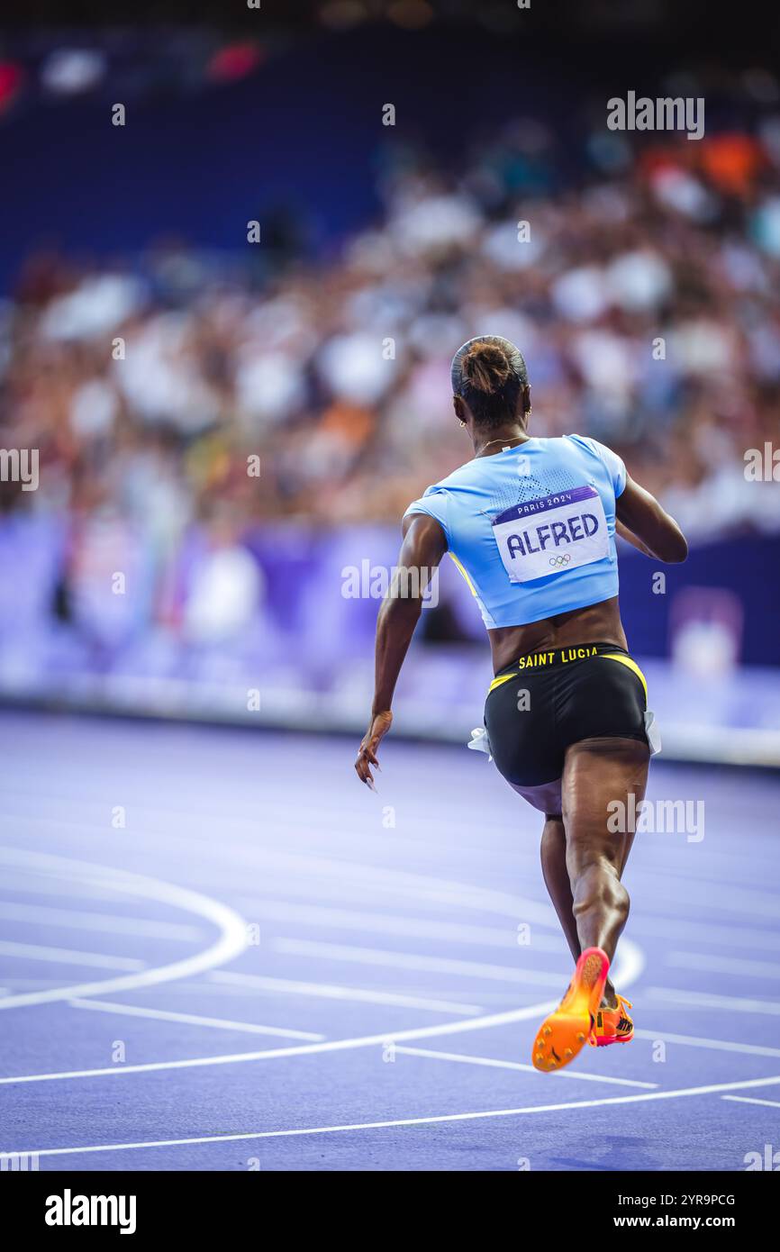 Julien Alfred participating in the 200 meters relay at the Paris 2024 ...