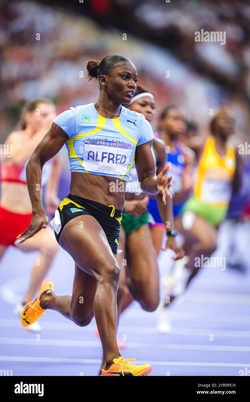 Julien Alfred participating in the 200 meters relay at the Paris 2024 ...
