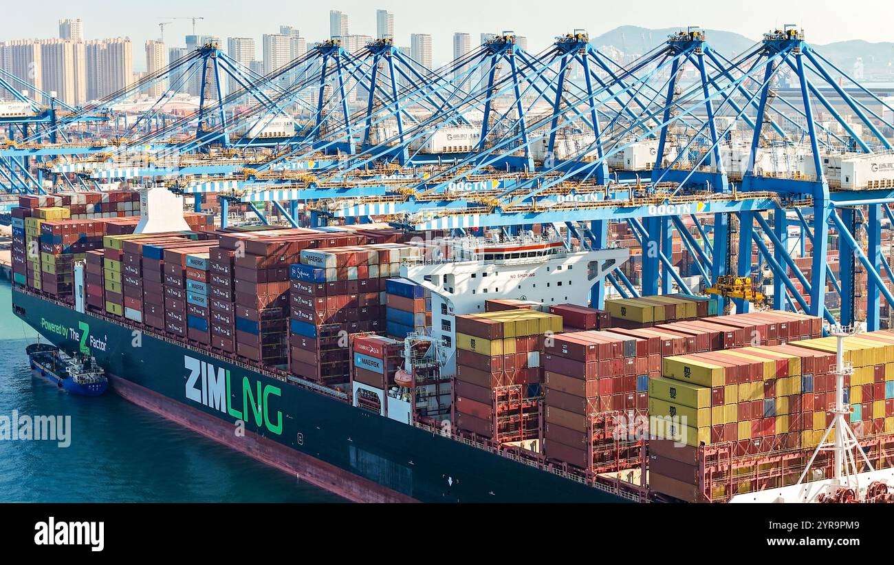 QINGDAO, CHINA - DECEMBER 3, 2024 - A cargo ship loading and unloading ...