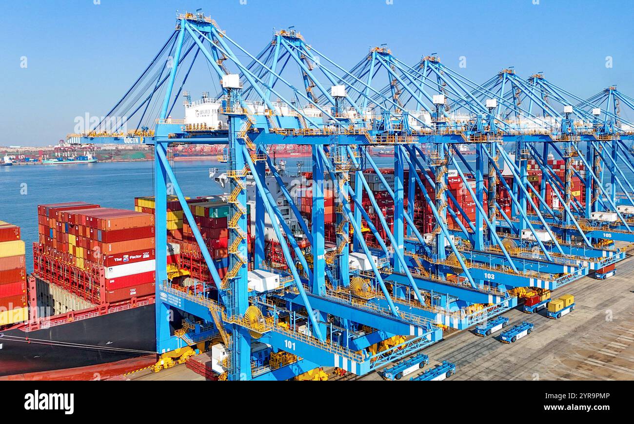 QINGDAO, CHINA - DECEMBER 3, 2024 - A cargo ship loading and unloading ...