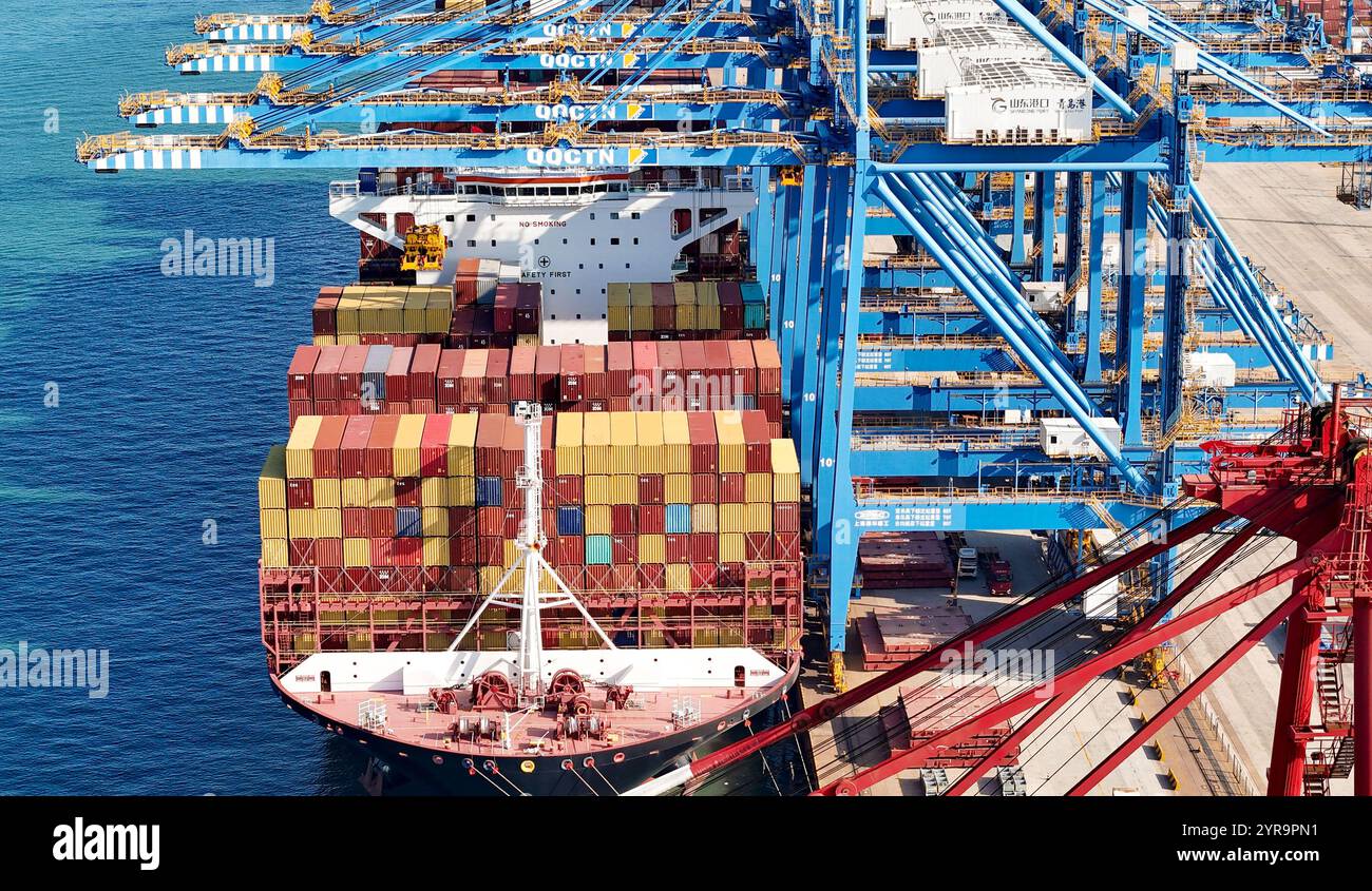 QINGDAO, CHINA - DECEMBER 3, 2024 - A cargo ship loading and unloading ...
