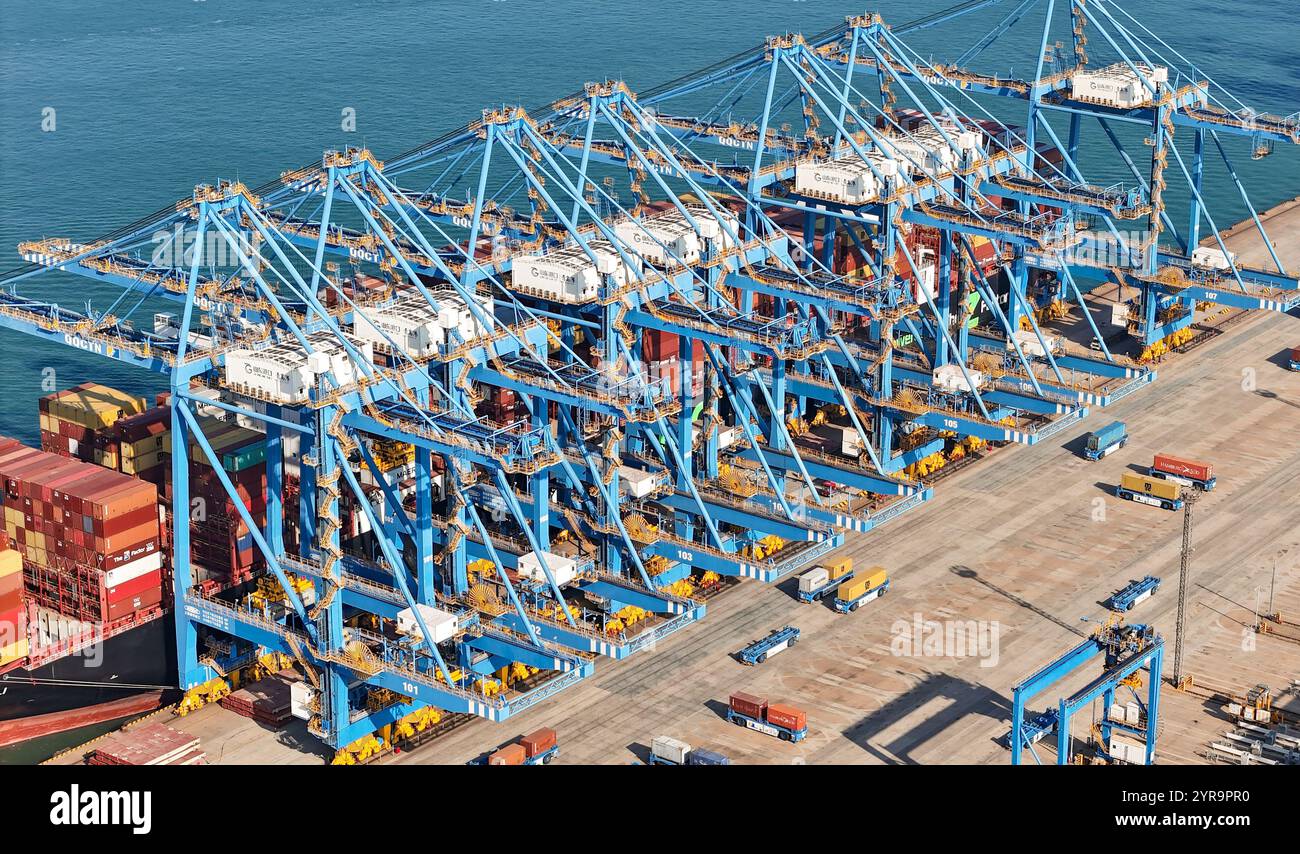 QINGDAO, CHINA - DECEMBER 3, 2024 - A cargo ship loading and unloading ...