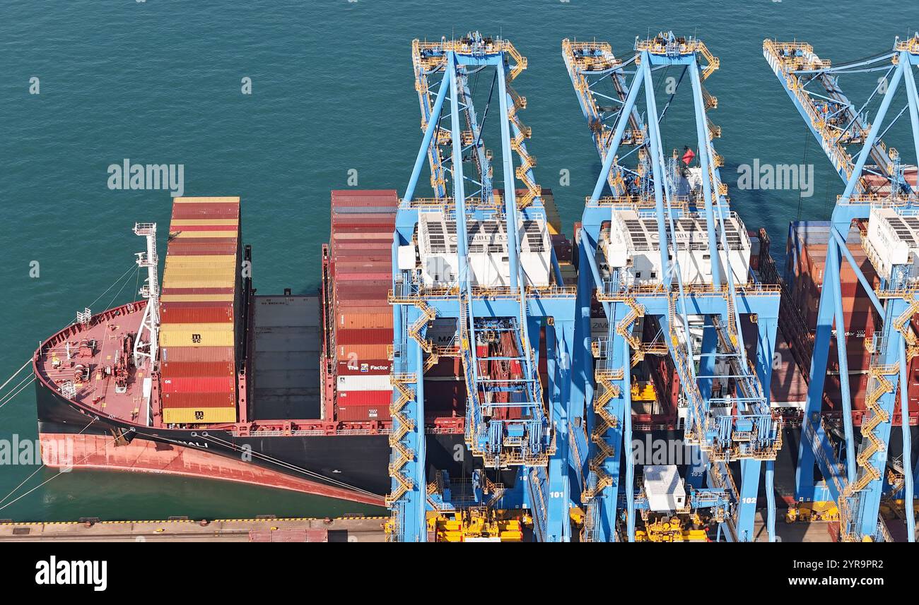 QINGDAO, CHINA - DECEMBER 3, 2024 - A cargo ship loading and unloading ...