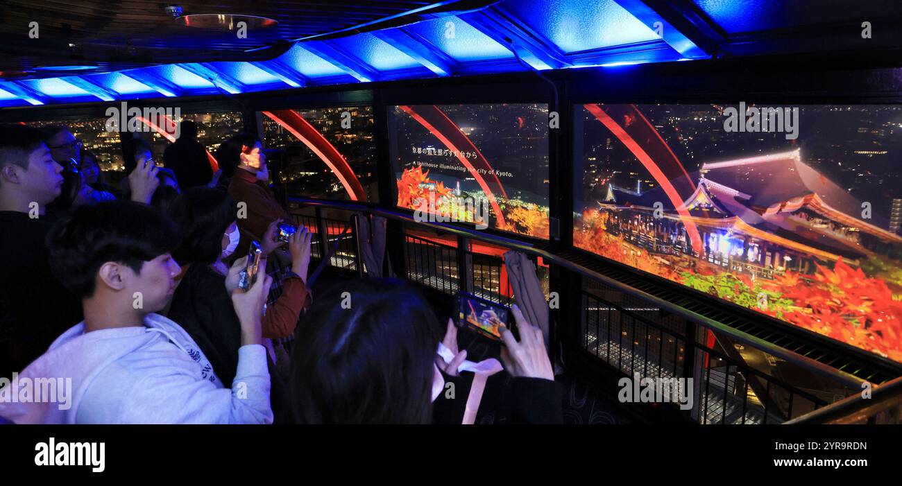 Some images are projected onto a translucent sheet along with the ...