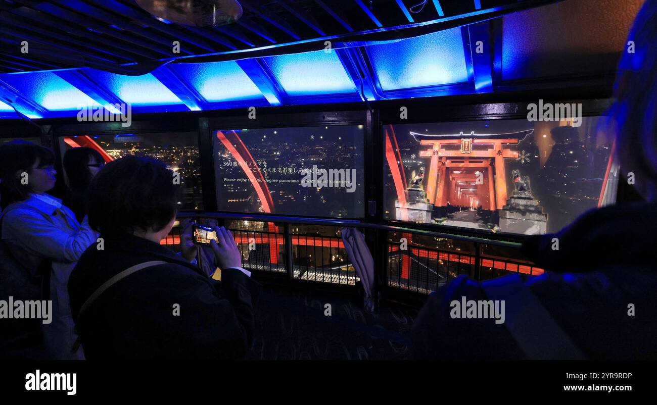 Some images are projected onto a translucent sheet along with the ...