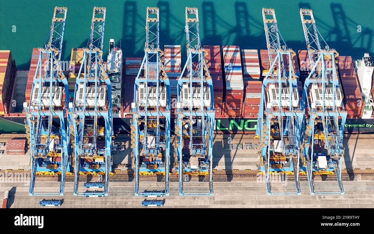 QINGDAO, CHINA - DECEMBER 3, 2024 - A cargo ship loading and unloading ...