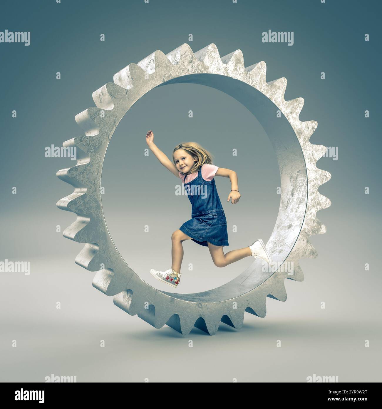 Young girl running inside a giant floating gear wheel Stock Photo - Alamy