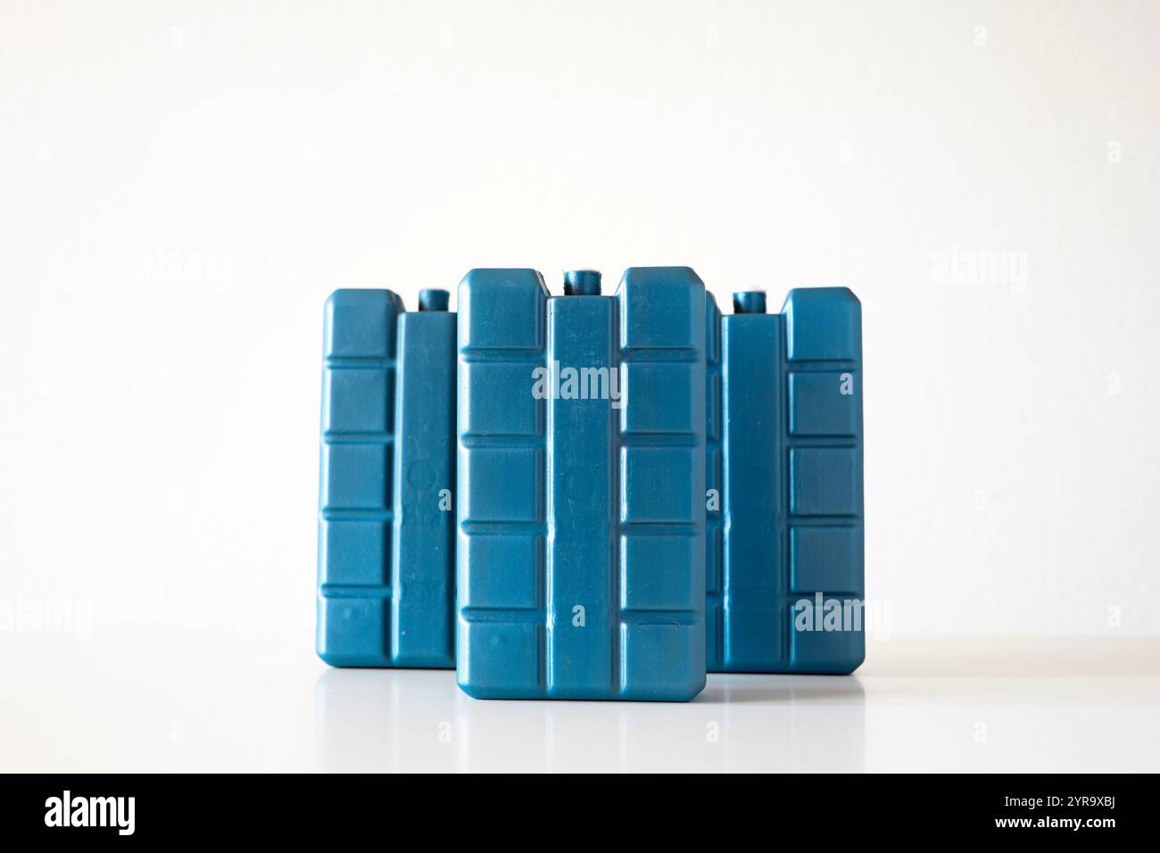 Three blue, plastic, freezer or fridge cooling elements with gel. Close ...