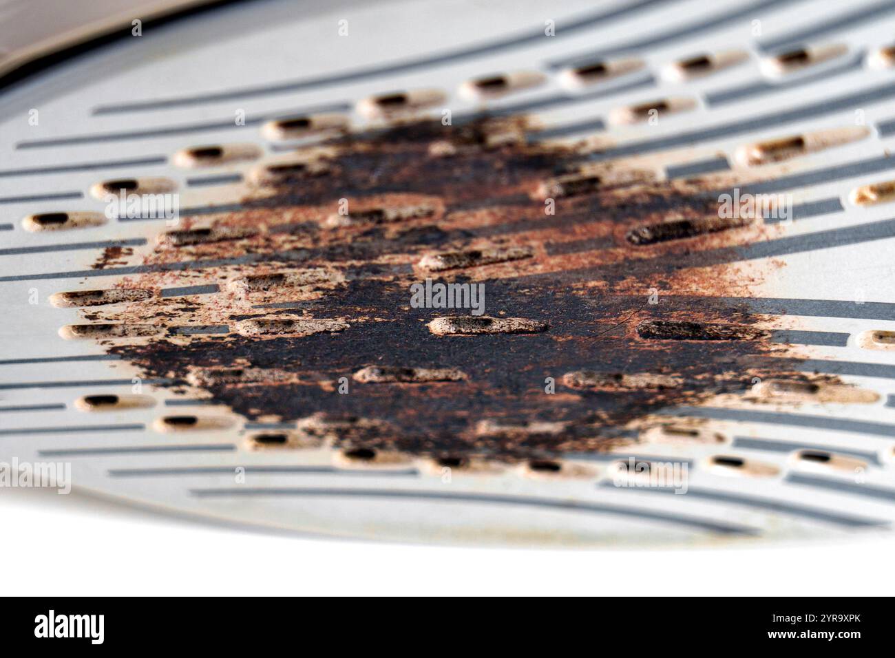 Close-up of a burned steam iron soleplate with visible scorch marks ...