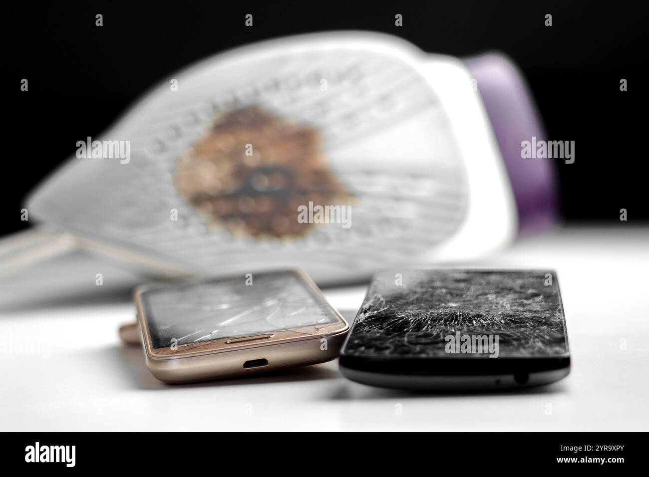 Old damaged smartphones with shattered cracked touch screens on a ...