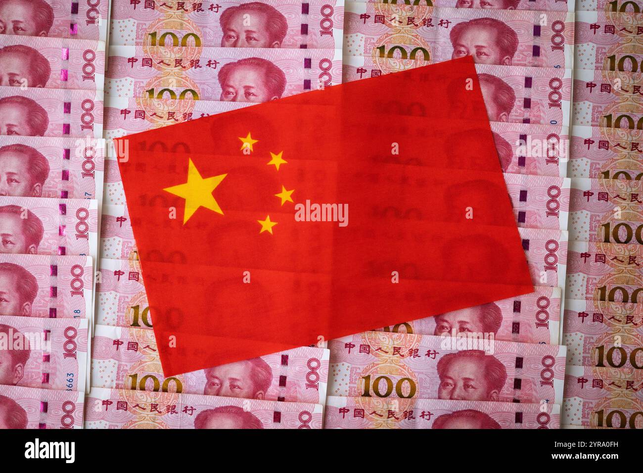 Close-up of Chinese flag and Chinese yuan combined. inflation. Interest ...