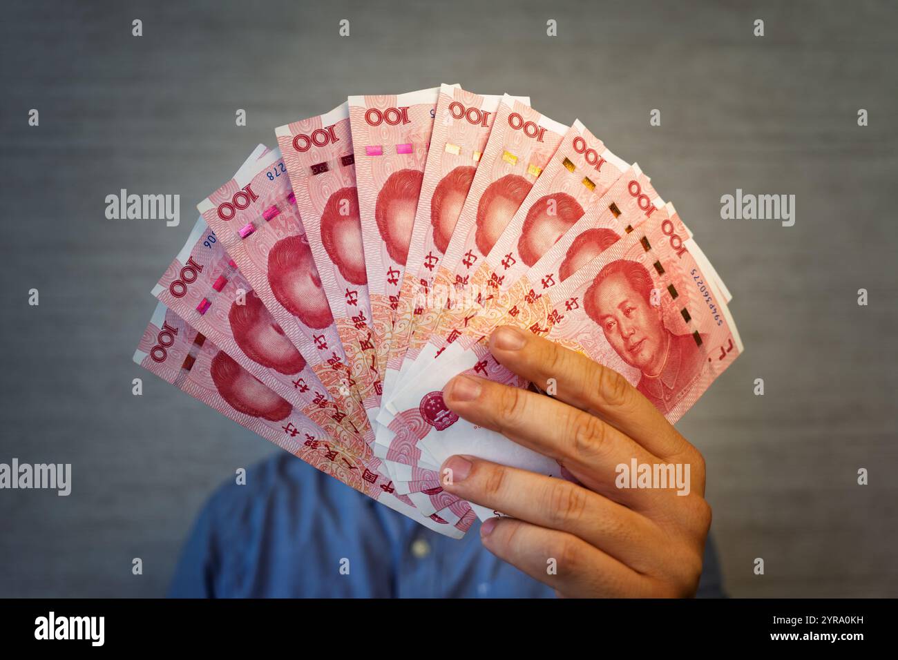 man hands hold a pack of Chinese yuan bill and leaf through showing ...