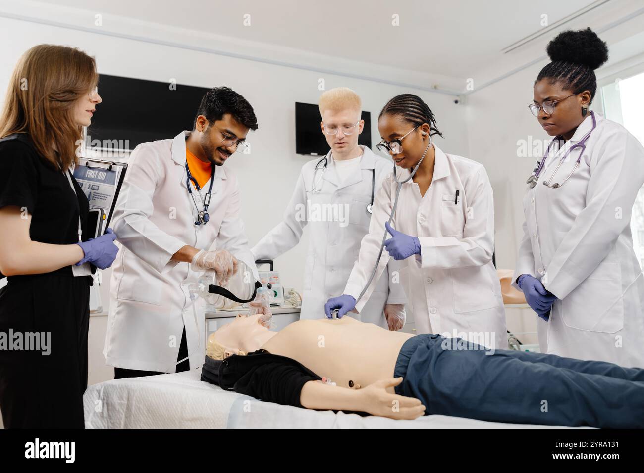 A couple of medical professionals are carefully performing a procedure ...