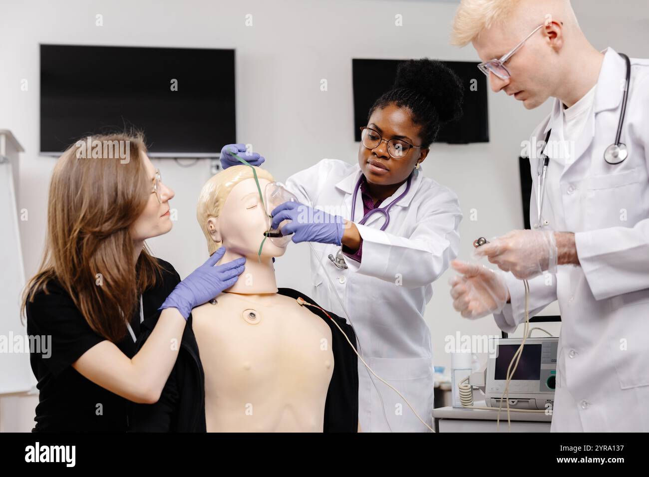 A female doctor is carefully examining a male mannequin in a medical ...