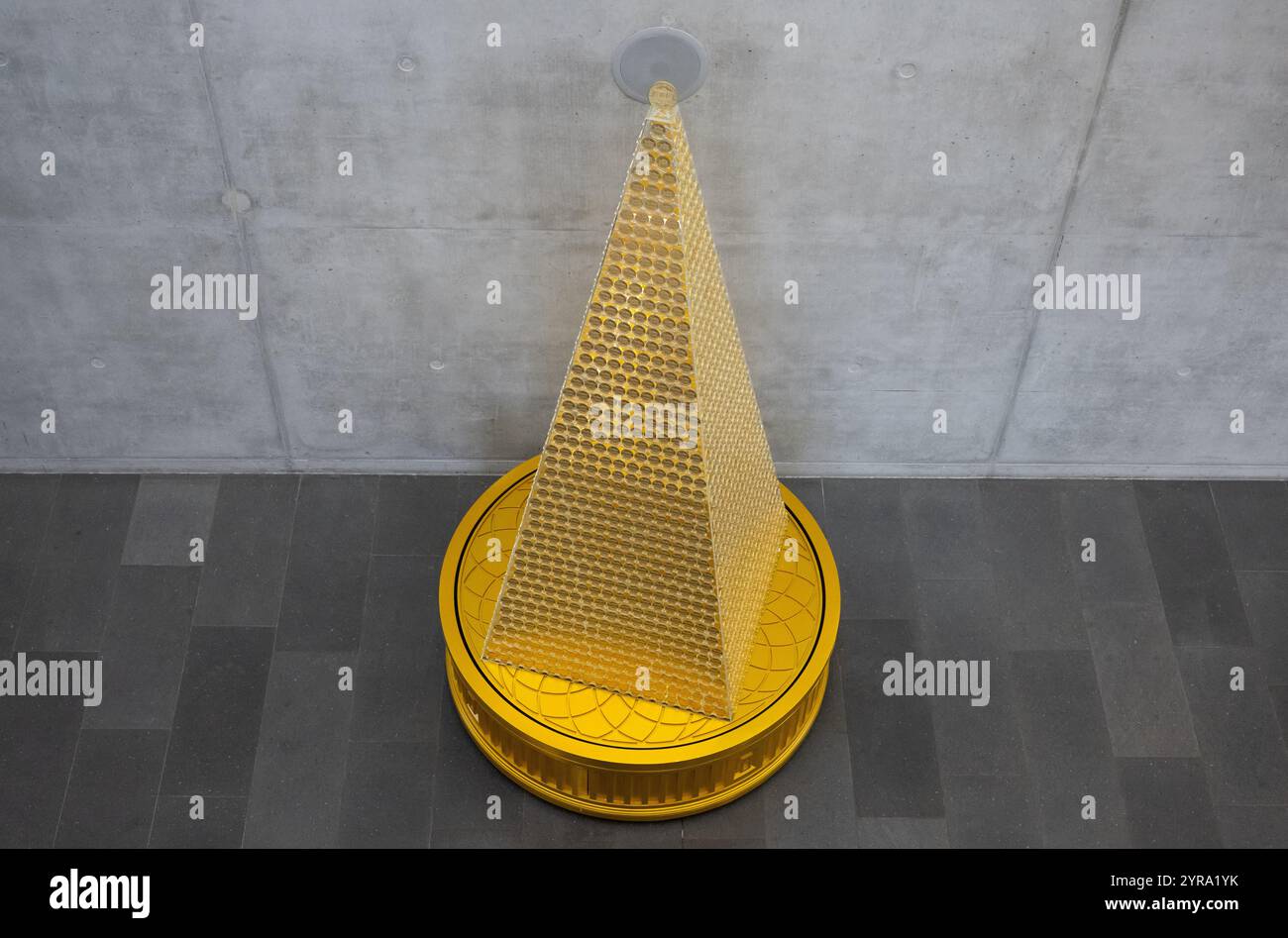 03 December 2024, Bavaria, Munich: A Christmas tree made of gold coins ...