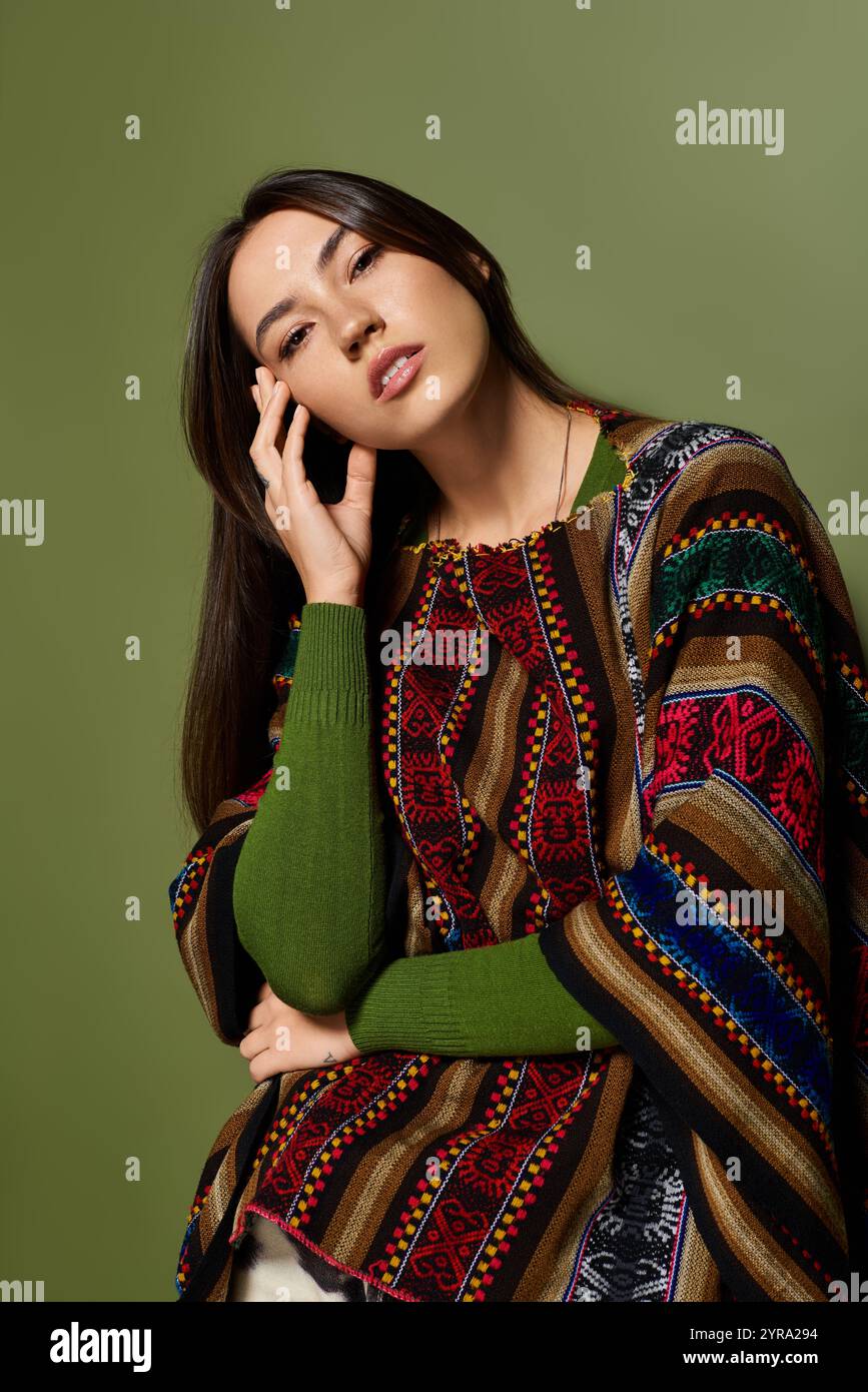 A beautiful young woman poses confidently while wearing a vibrant ...