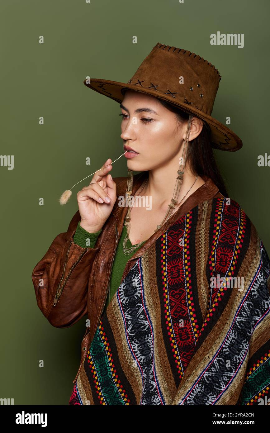 Beautiful young brunette woman wears a traditional outfit while holding ...