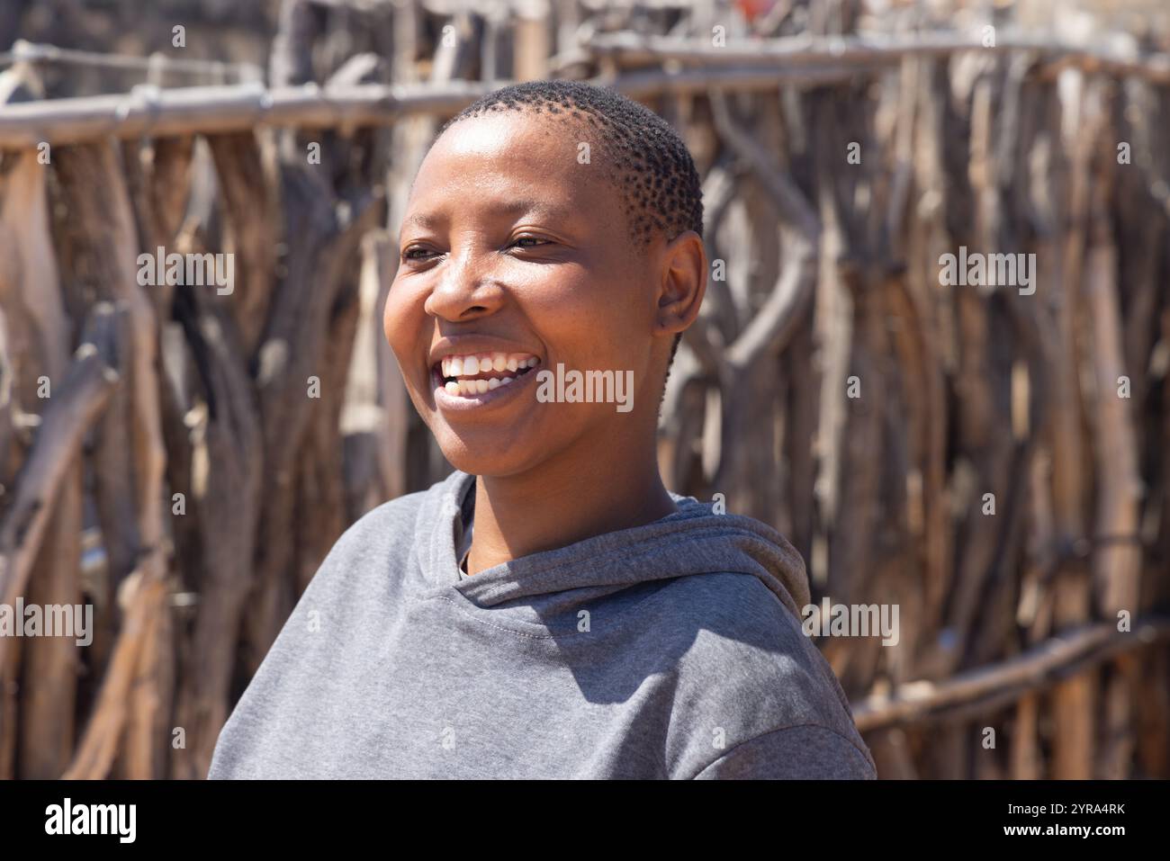 village single portrait african happy young woman outdoors in the yard ...