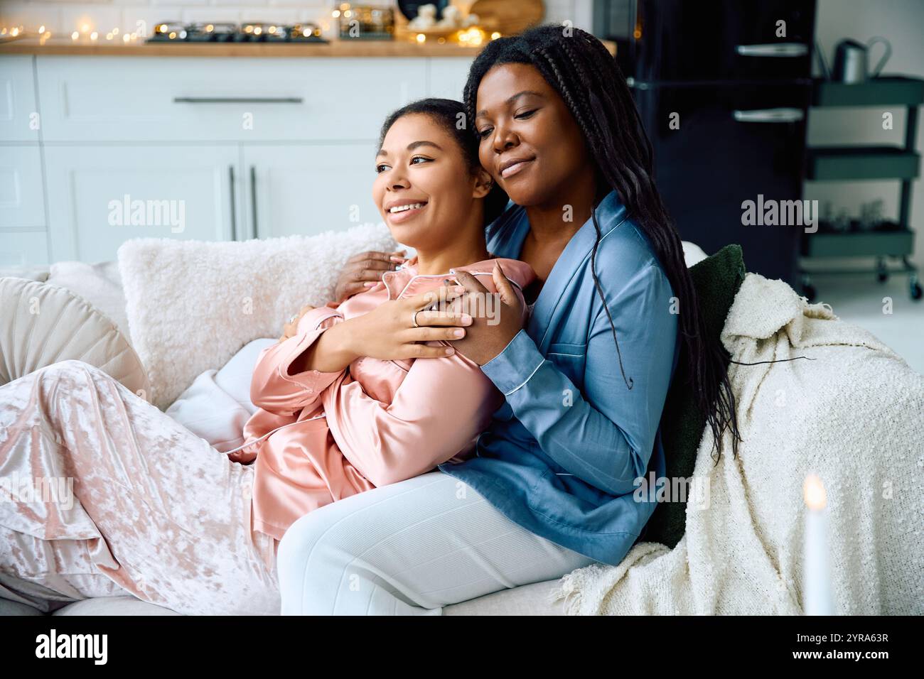 Two women share a tender moment, wrapped in warmth and affection while ...