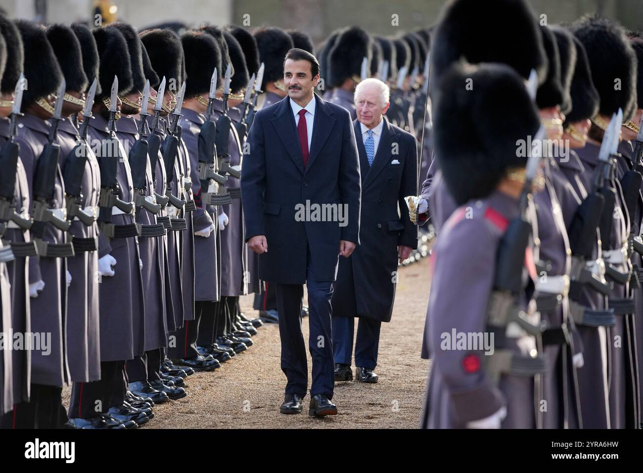 King Charles III and the Emir of Qatar Sheikh Tamim bin Hamad Al Thani inspect a guard of honour ...