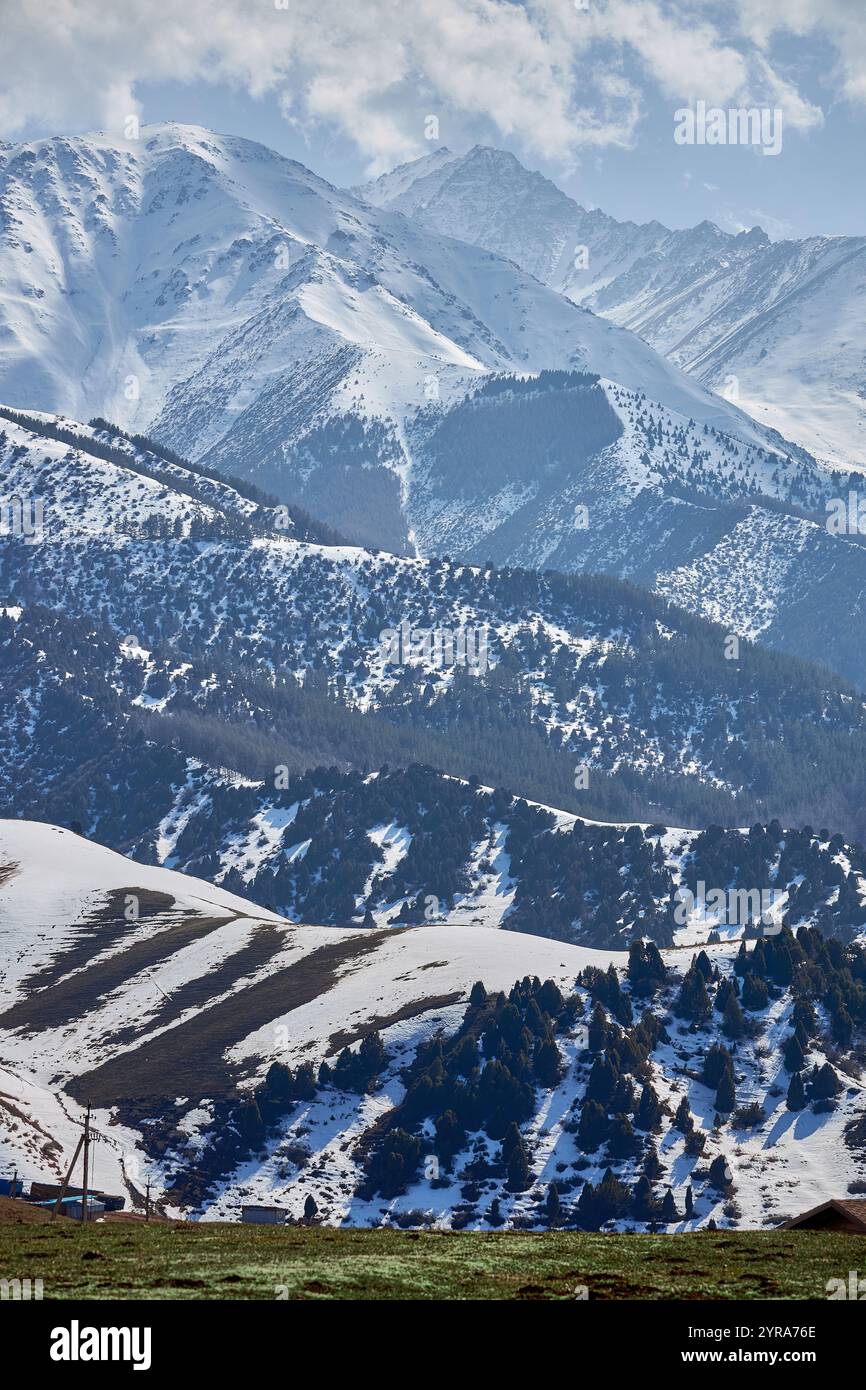 Snow capped hills and green grass, mountains. Chunkurchak valley in ...