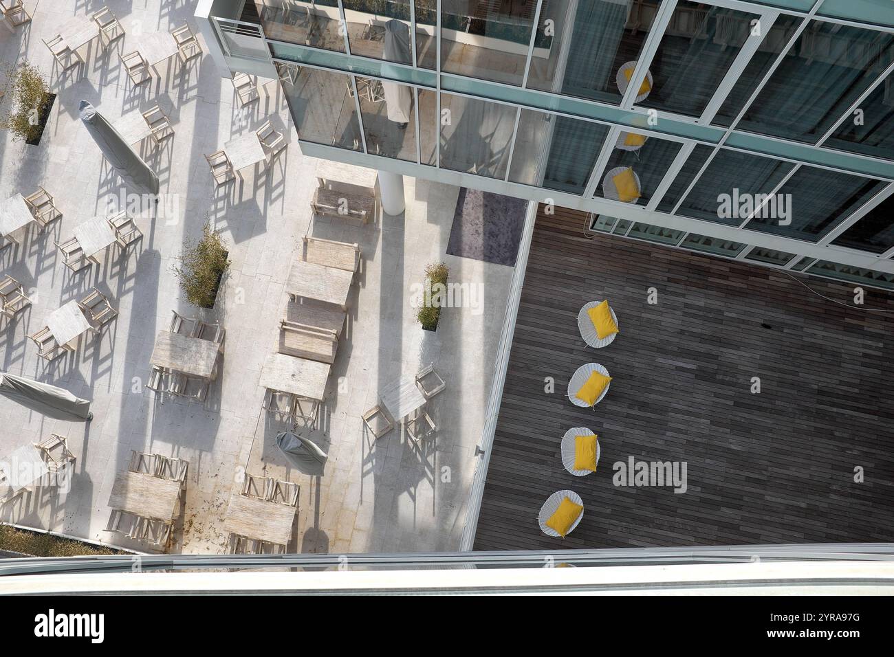 Detail of the terrace with tables and wooden floor, of a modern ...
