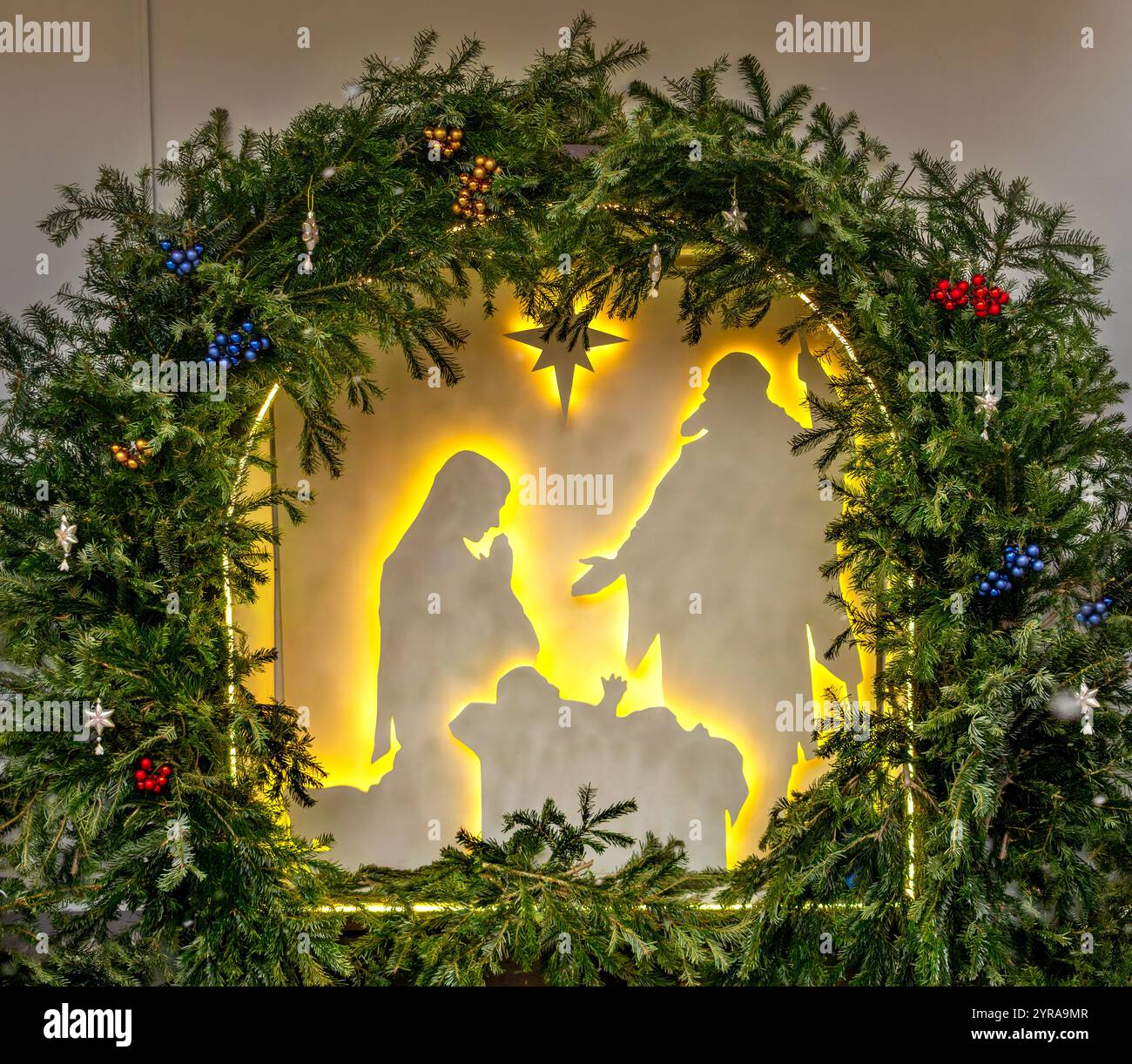 Nativity creche depicted by lighting effect in center of wreath of ...