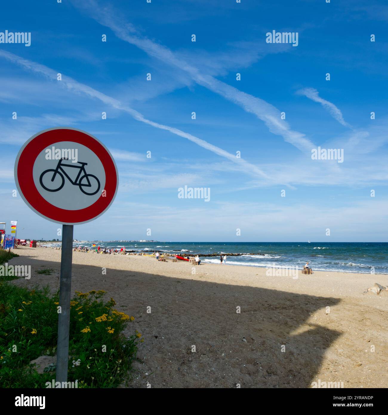Red and white prohibition sign for bicycles in front of the sandy beach ...
