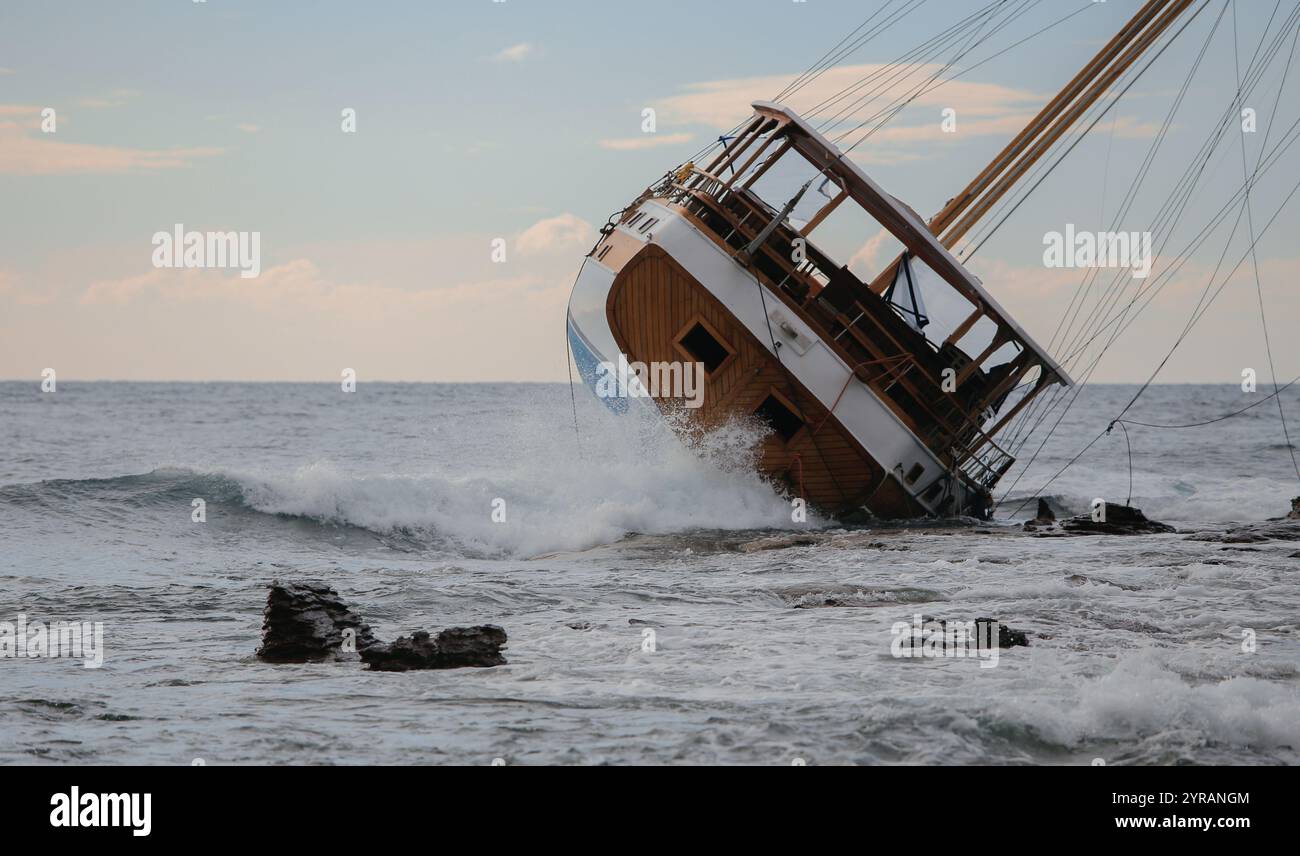 Captivating image of a shipwreck leaning on rocks in a rough sea during ...