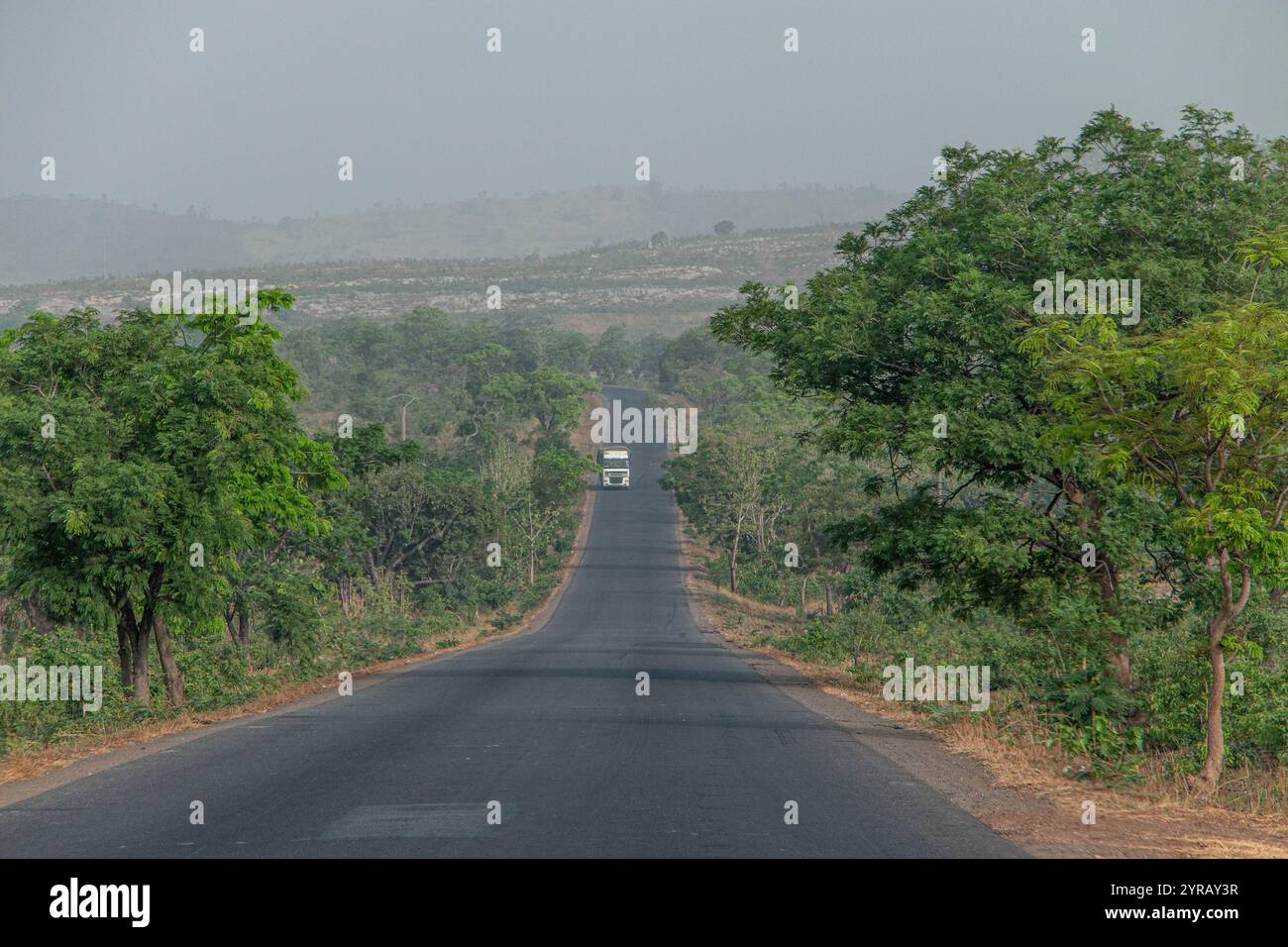 Peaceful Rural Road in Togo Surrounded by Dense Trees and Rolling ...